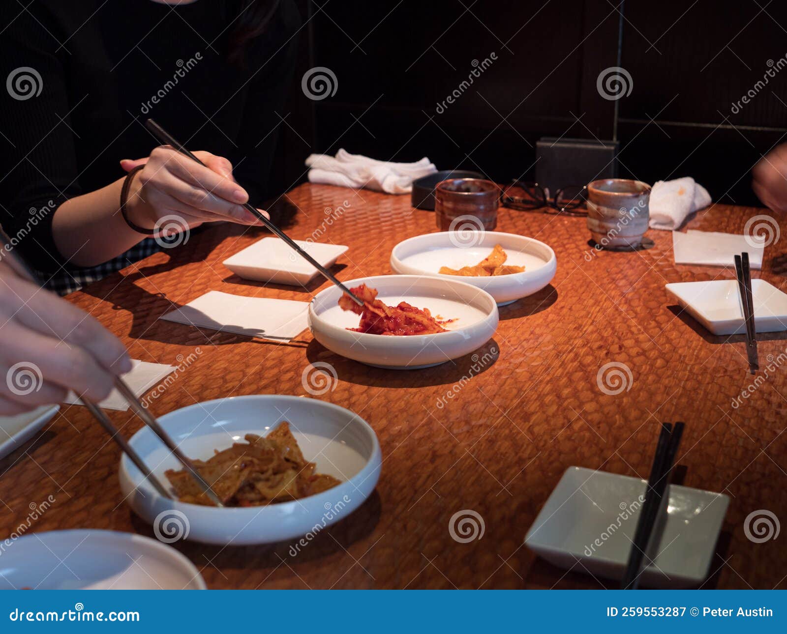 Hands Picking at Side Dishes in a Korean Restaurant Stock Image - Image ...