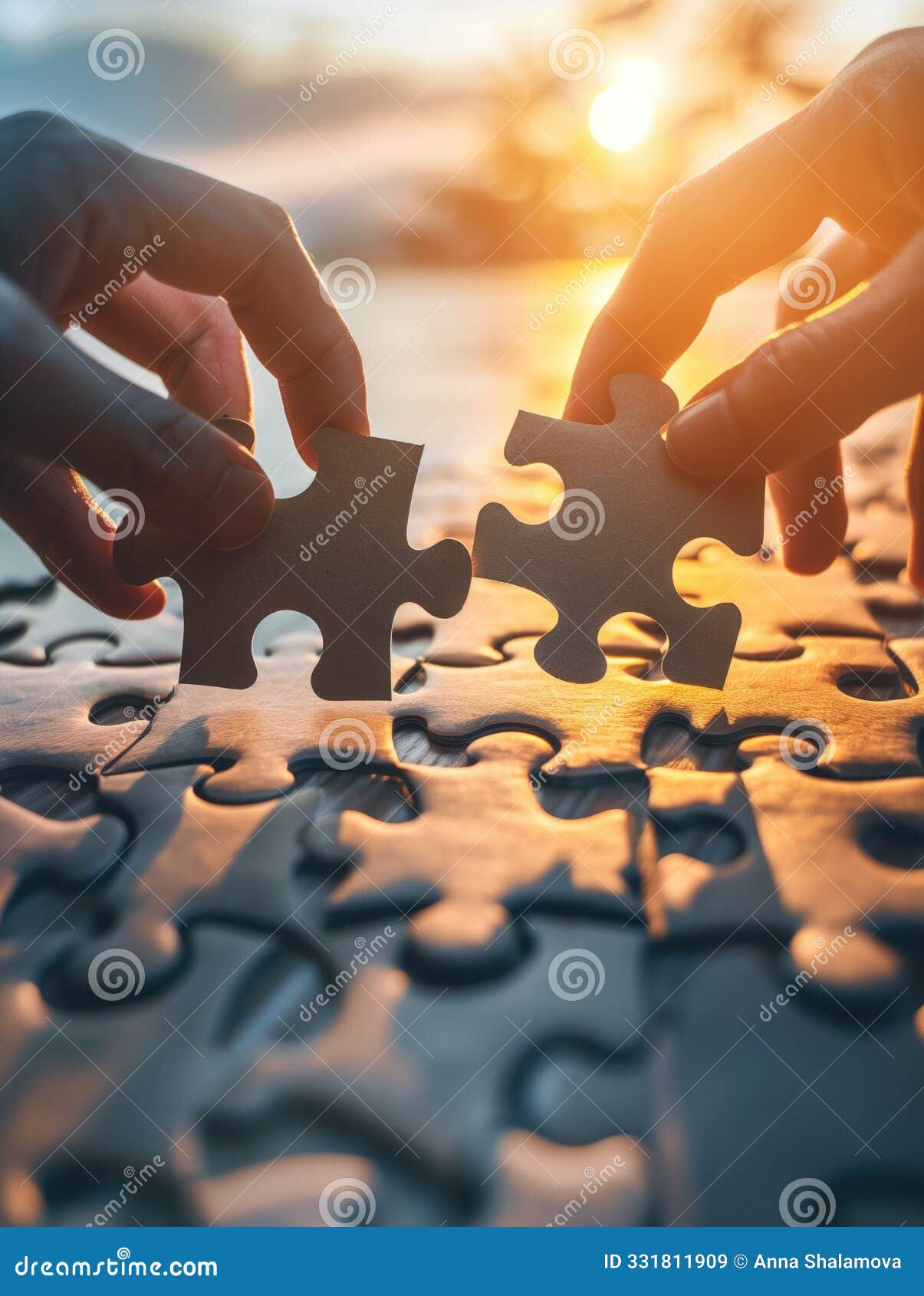 Hands Placing Puzzle Pieces Together on a Table with a Sunset in the ...
