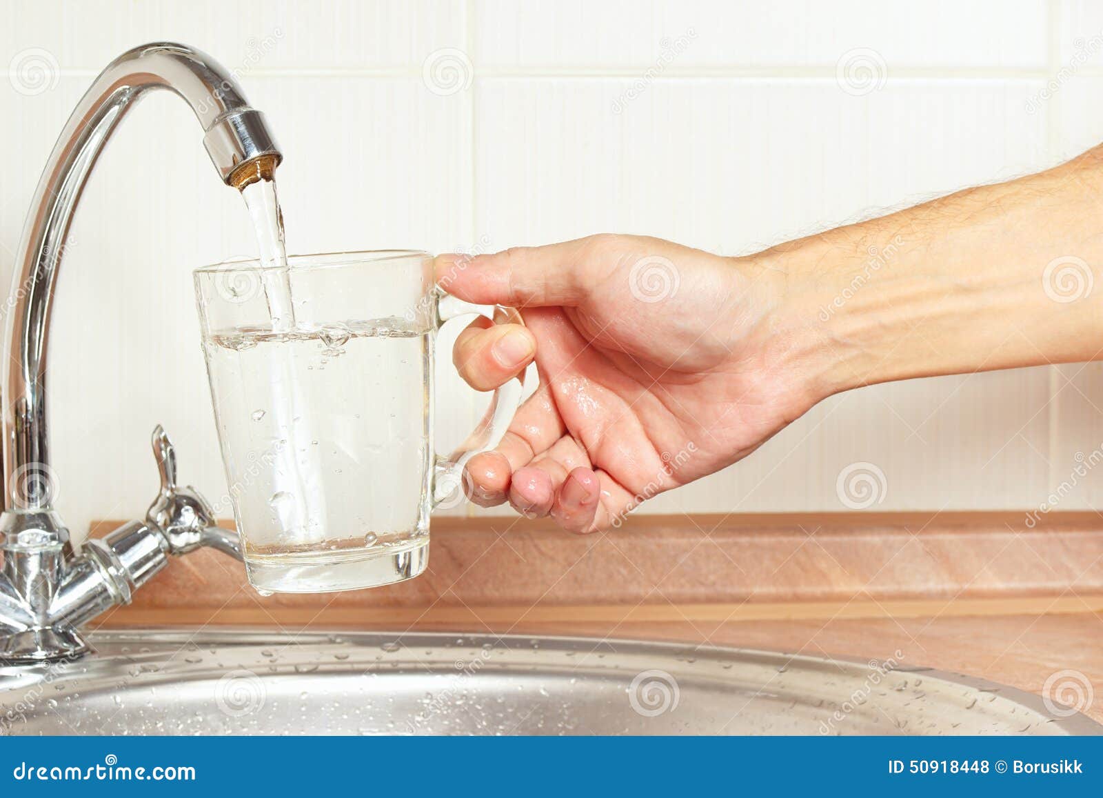 Hands Pour Fresh Water into the Glass Under the Tap in Kitchen Stock ...