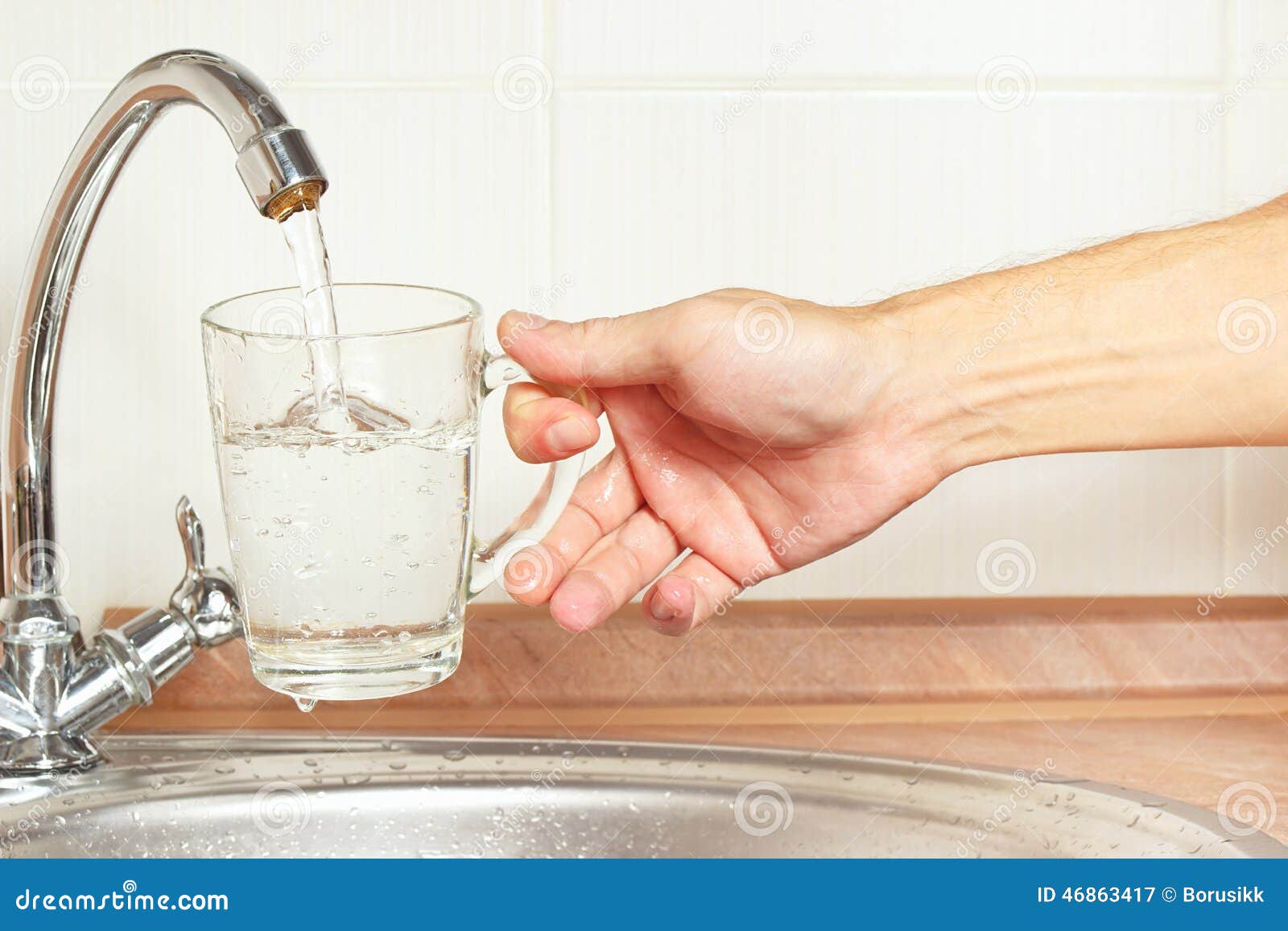 Hands Pour Water into the Glass Under the Tap in Kitchen Stock Image ...