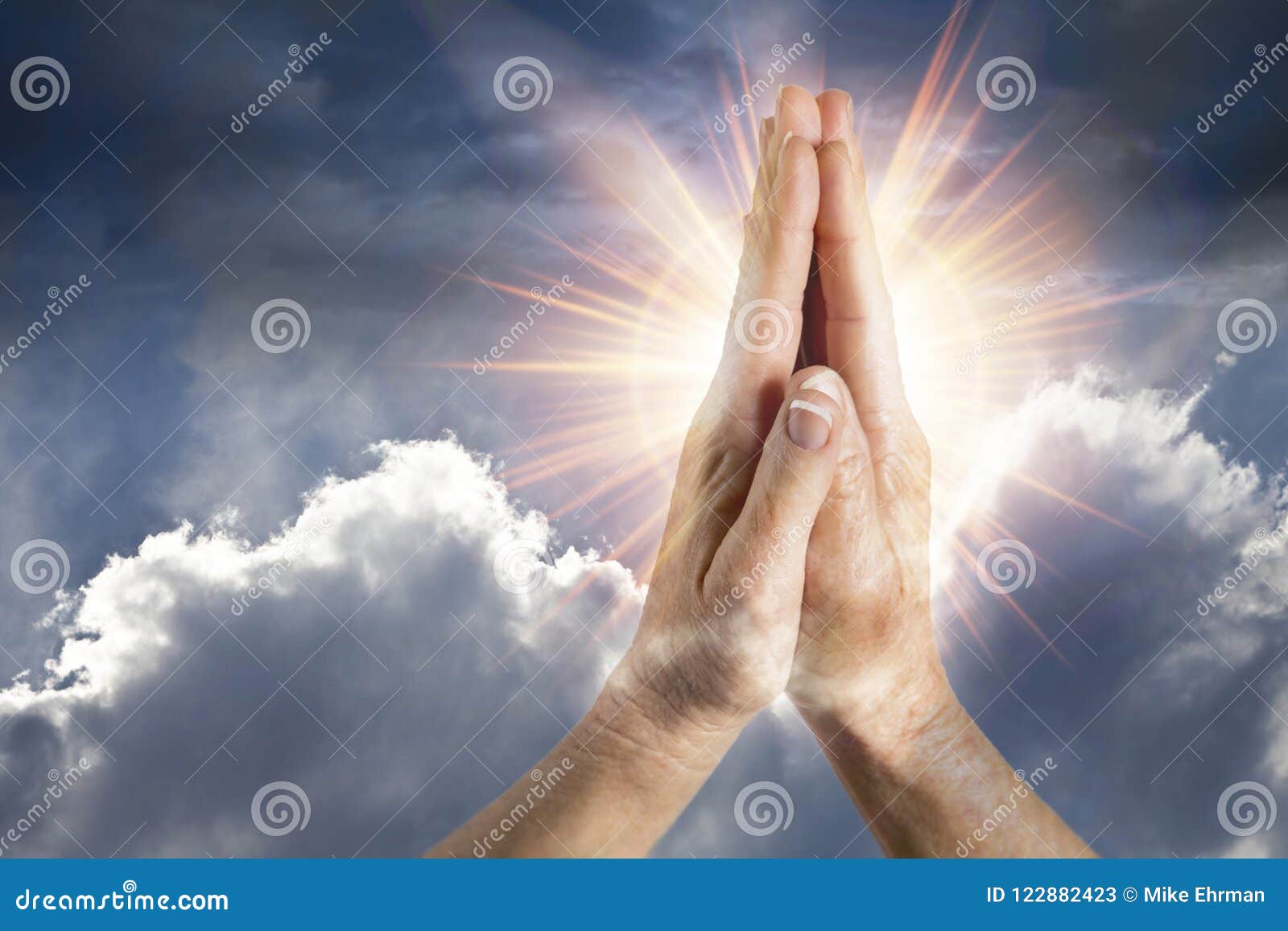 Hands in Prayer with Sun and Clouded Background Stock Image - Image of ...