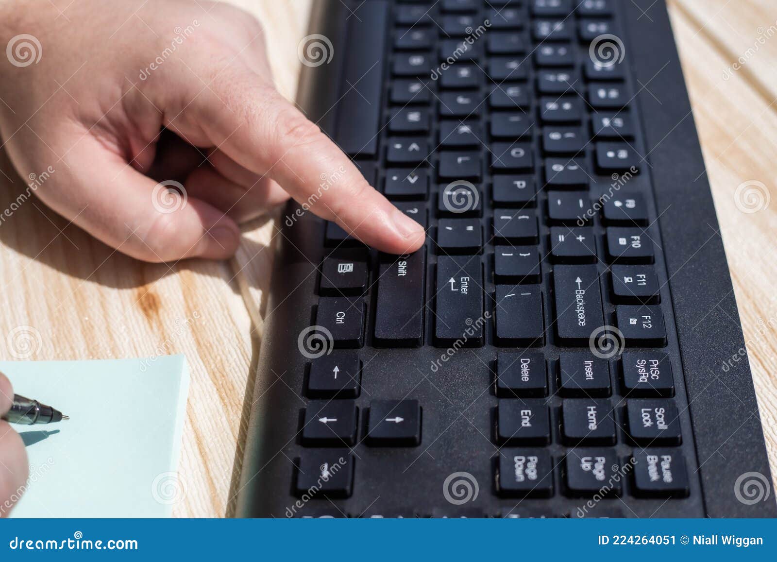 Hands Pressing Computer Keyboard Keys while Writing with Pencil in ...