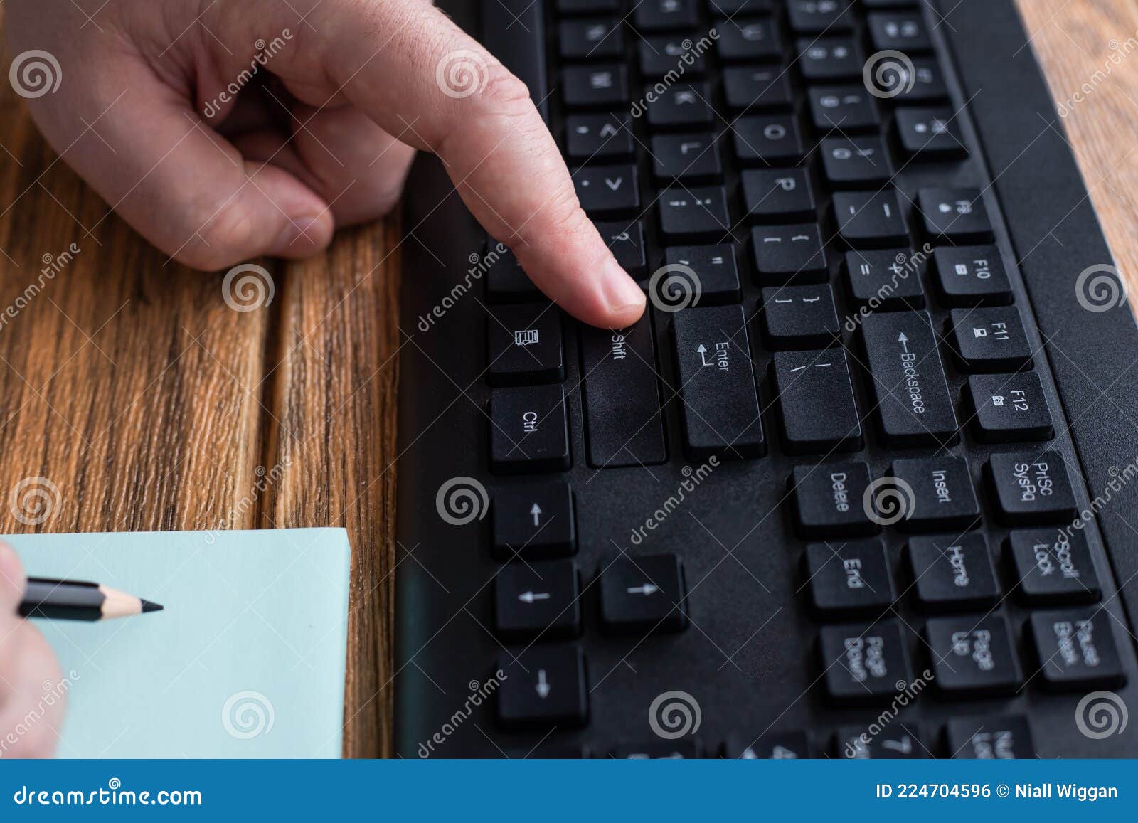 Hands Pressing Computer Keyboard Keys while Writing with Pencil in ...