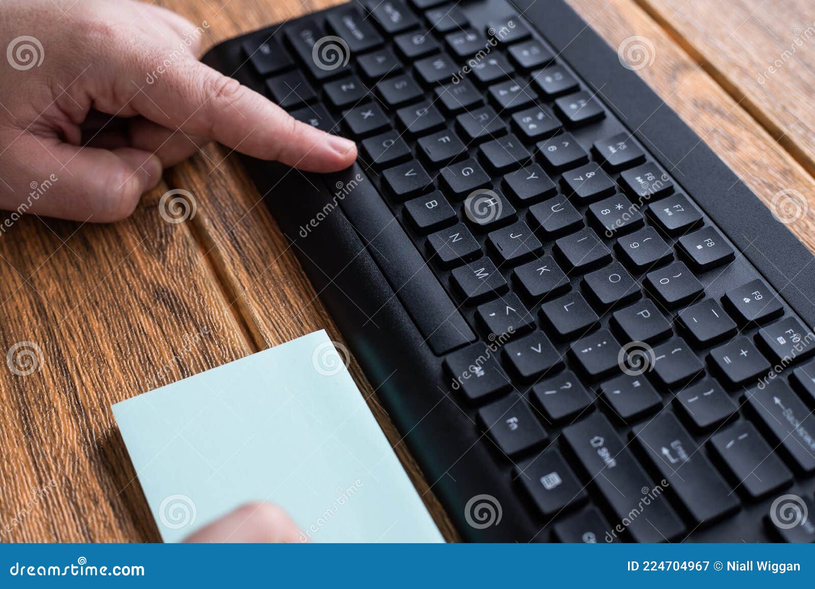 Hands Pressing Computer Keyboard Keys while Writing with Pencil in ...