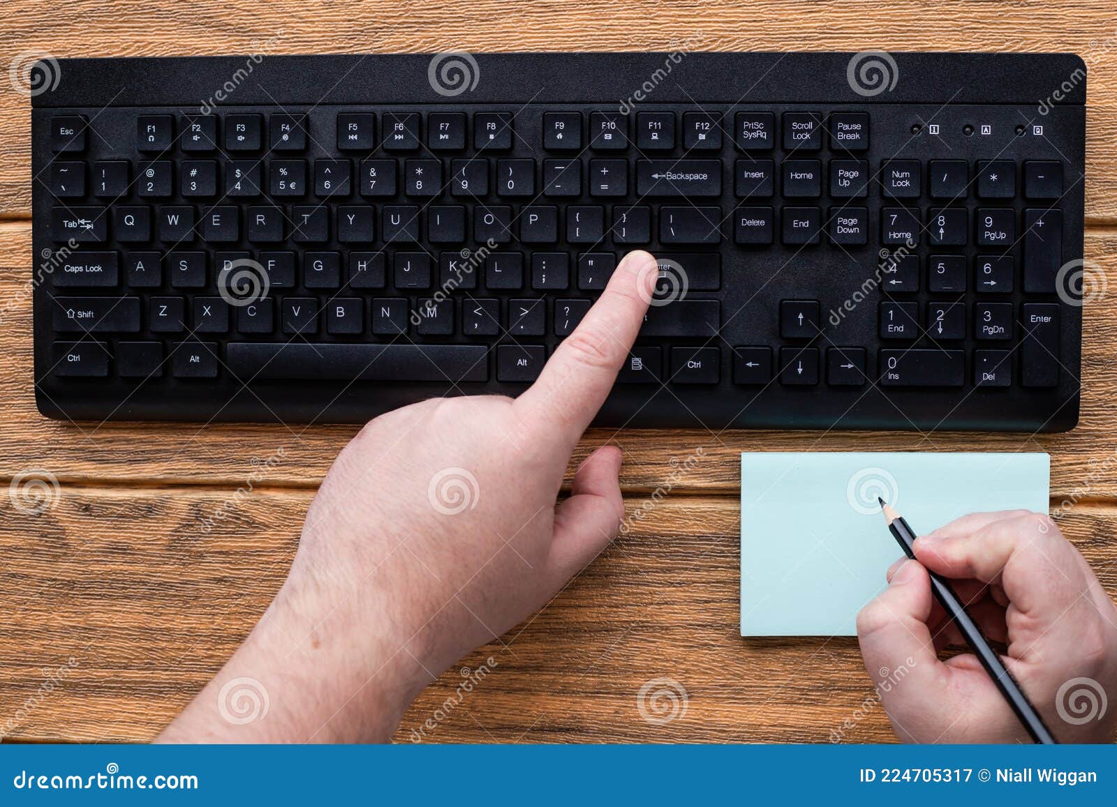Hands Pressing Computer Keyboard Keys while Writing with Pencil in ...
