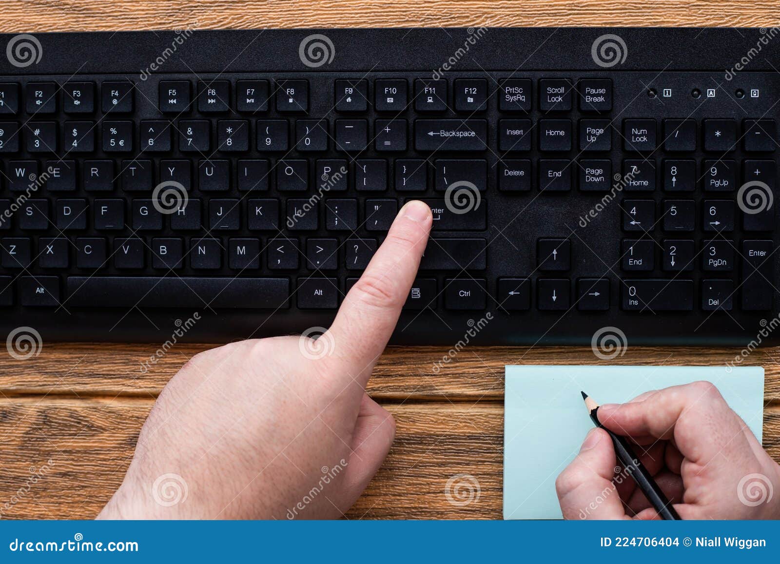 Hands Pressing Computer Keyboard Keys while Writing with Pencil in ...