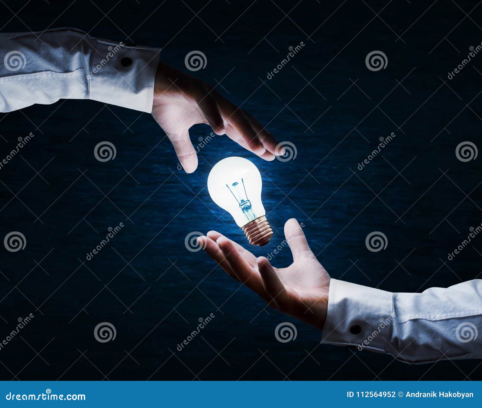Hands protect light bulb. stock photo. Image of invention - 112564952