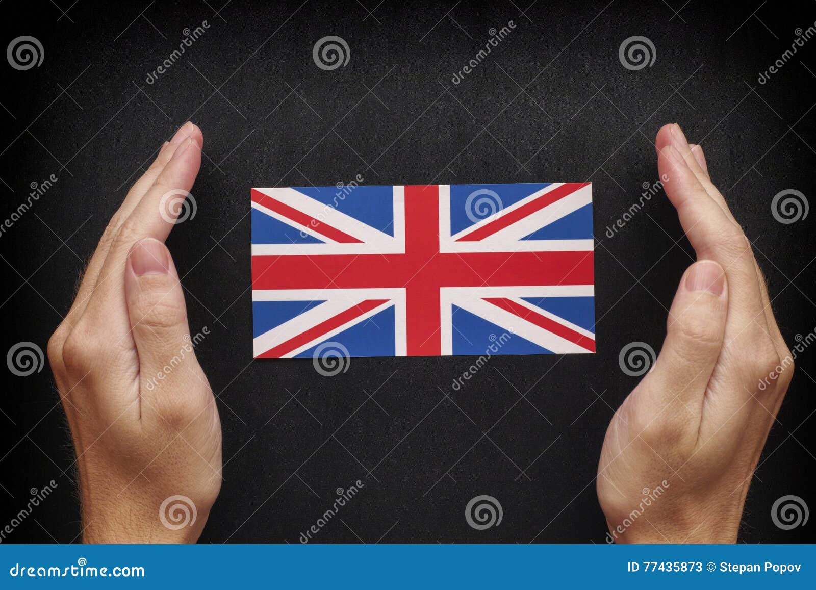 Hands Protecting British Flag on Black Chalkboard Background Stock ...