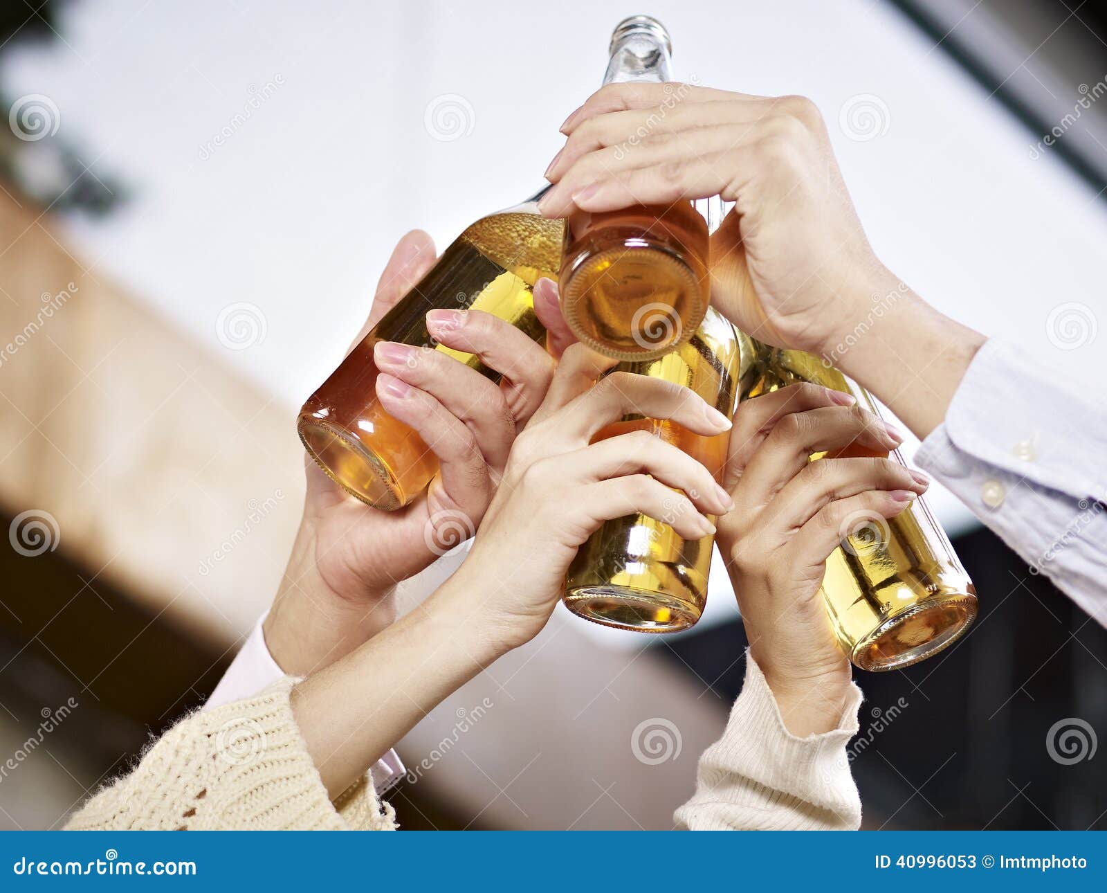 Hands Raising Beer Bottles for a Toast Stock Image - Image of time ...