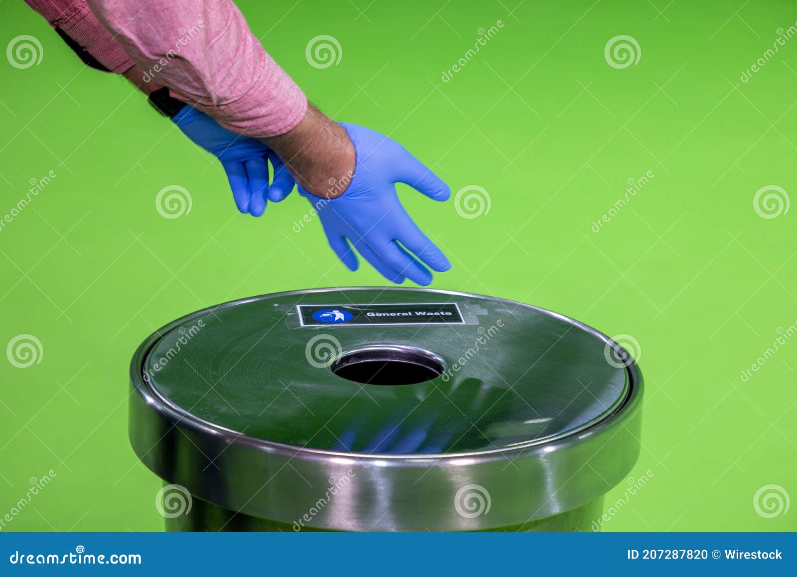 Hands Remove Glove on Green Background and Dump into Trash Can. Stock ...