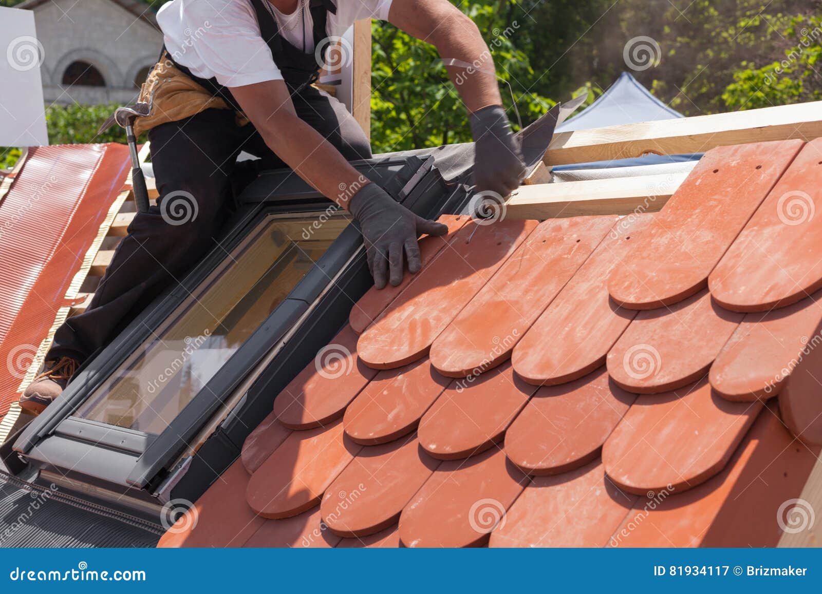 Hands of Roofer Laying Tile on the Roof. Installing Natural Red Tile ...