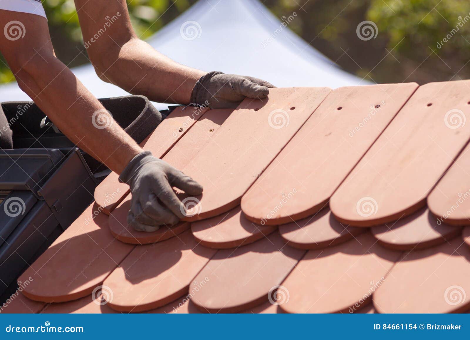 Hands of Roofer Laying Tile on the Roof. Installing Natural Red Tile ...