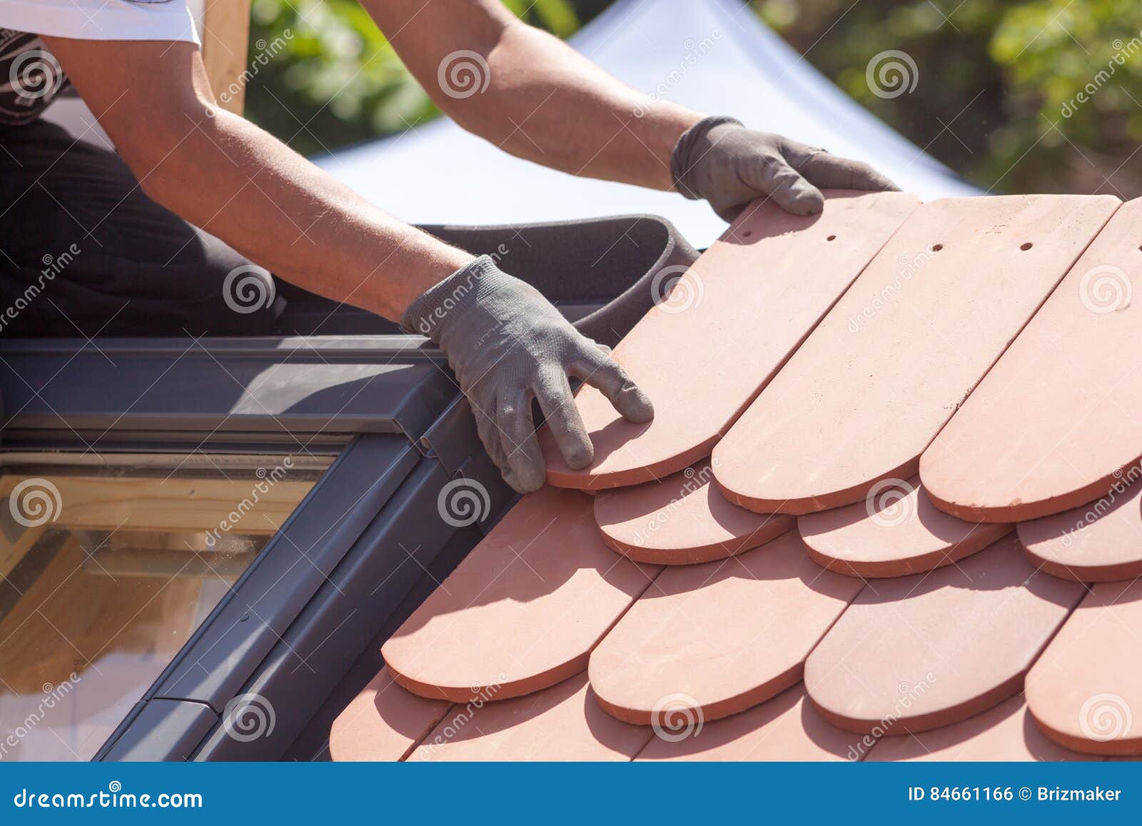 Hands Of Roofer Laying Tile On The Roof. Installing Natural Red Tile ...