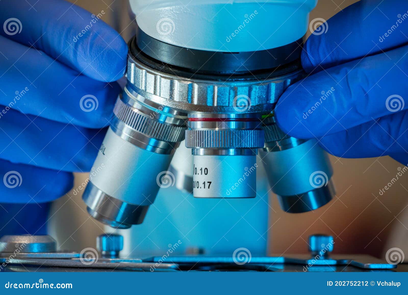 Hands of Scientist Adjusting Microscope in Laboratory. Stock Photo ...