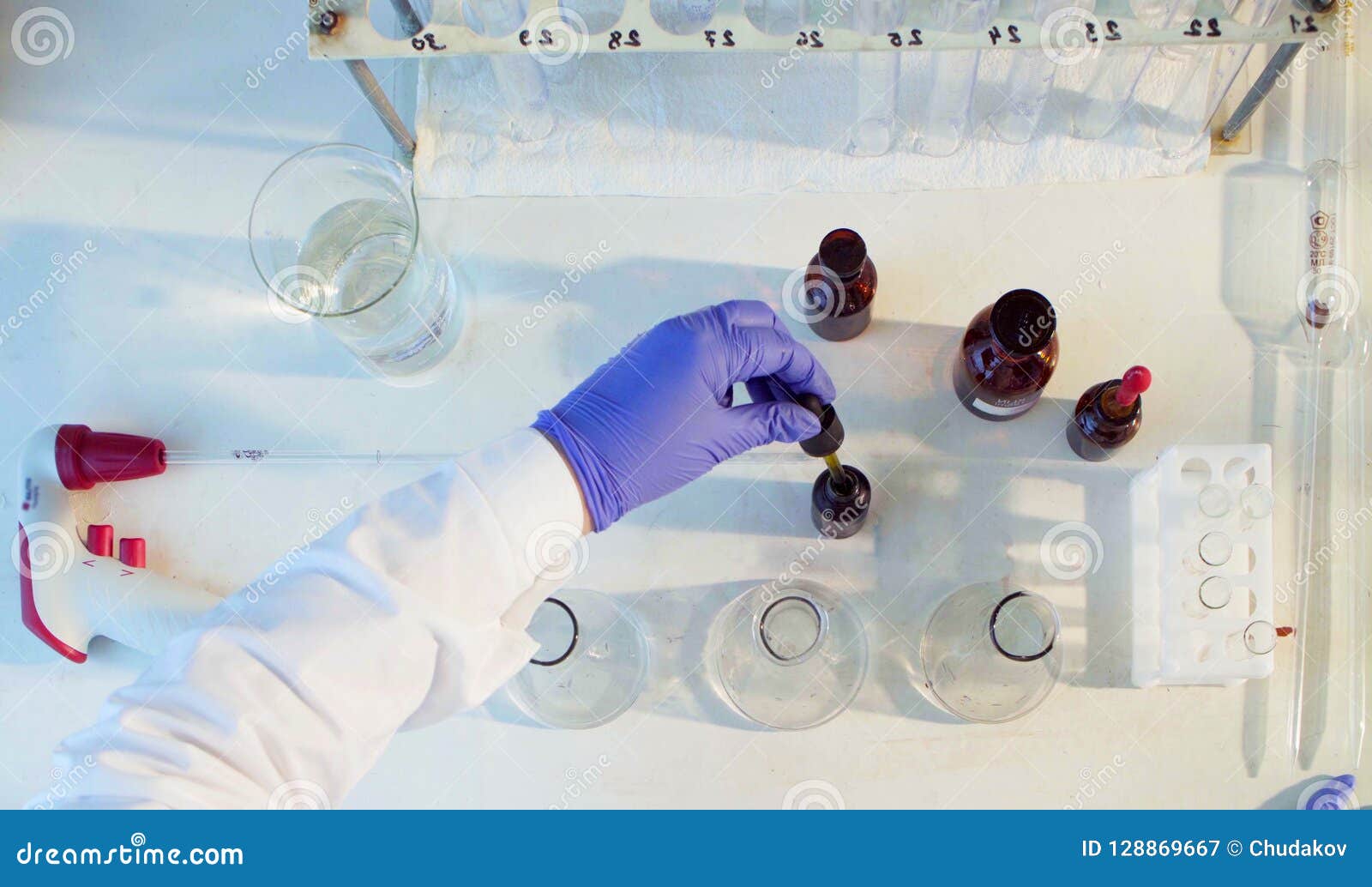 Hands of a Scientist Dropping a Reagent To Flasks Stock Image - Image ...
