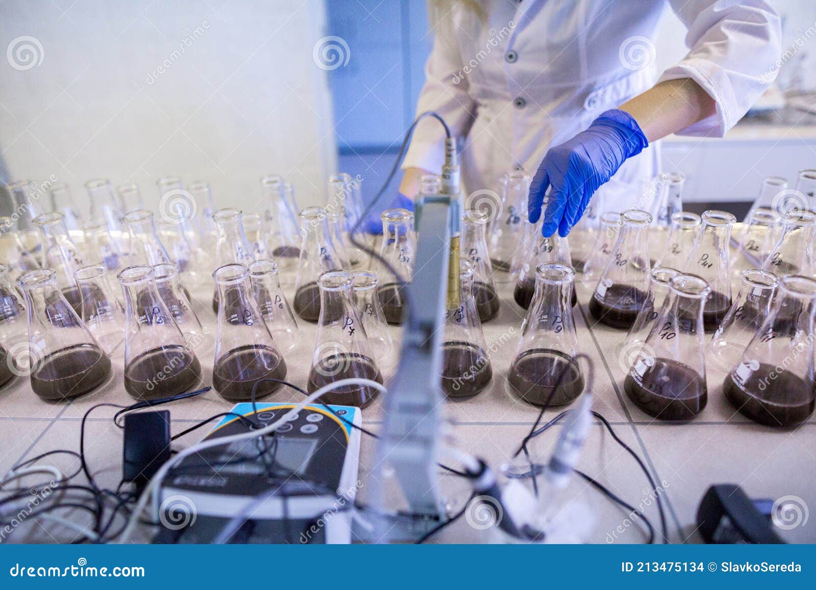 Hands of the Scientist in Laboratory Shake a Glass Flasks with ...