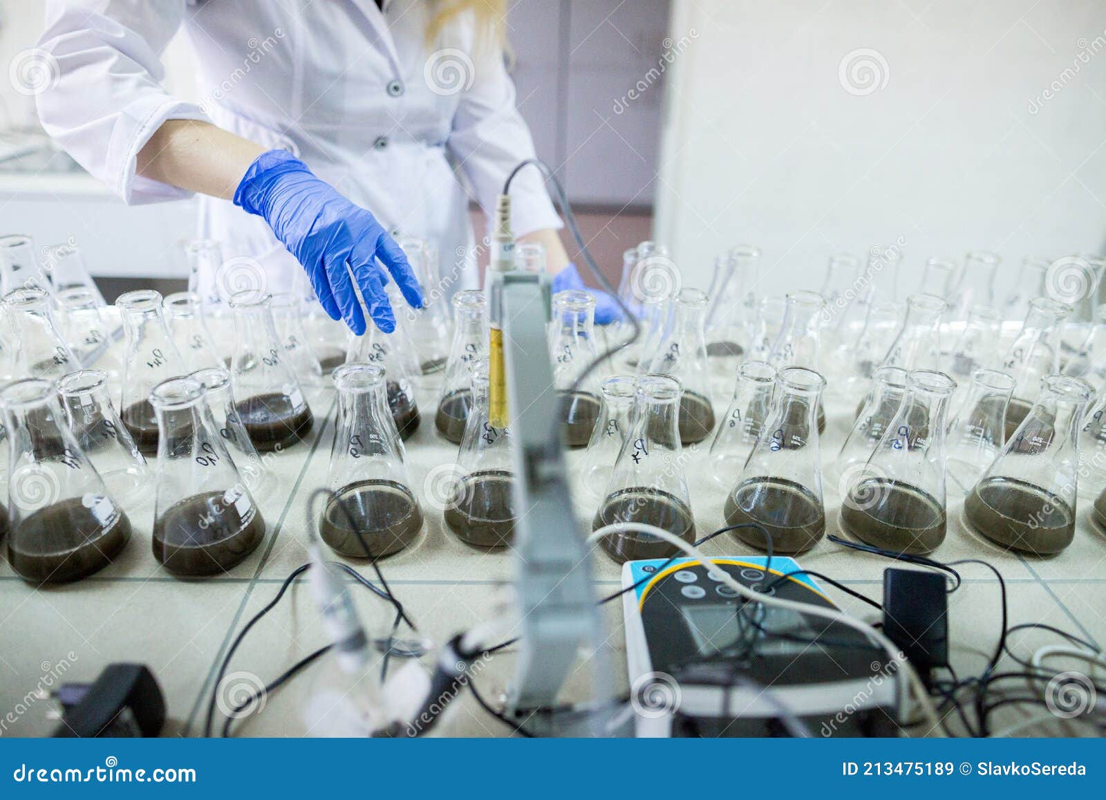 Hands of the Scientist in Laboratory Shake a Glass Flasks with ...