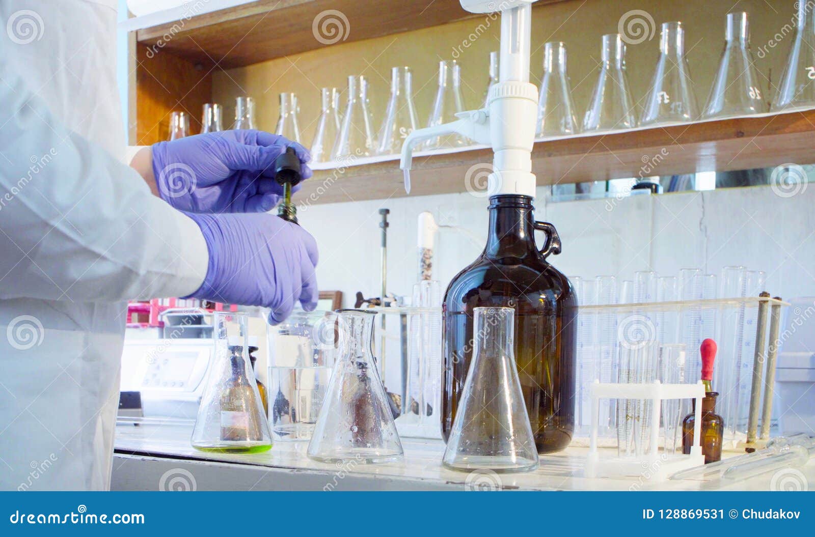 Hands of a Scientist Pouring Solution into Flasks Stock Image - Image ...