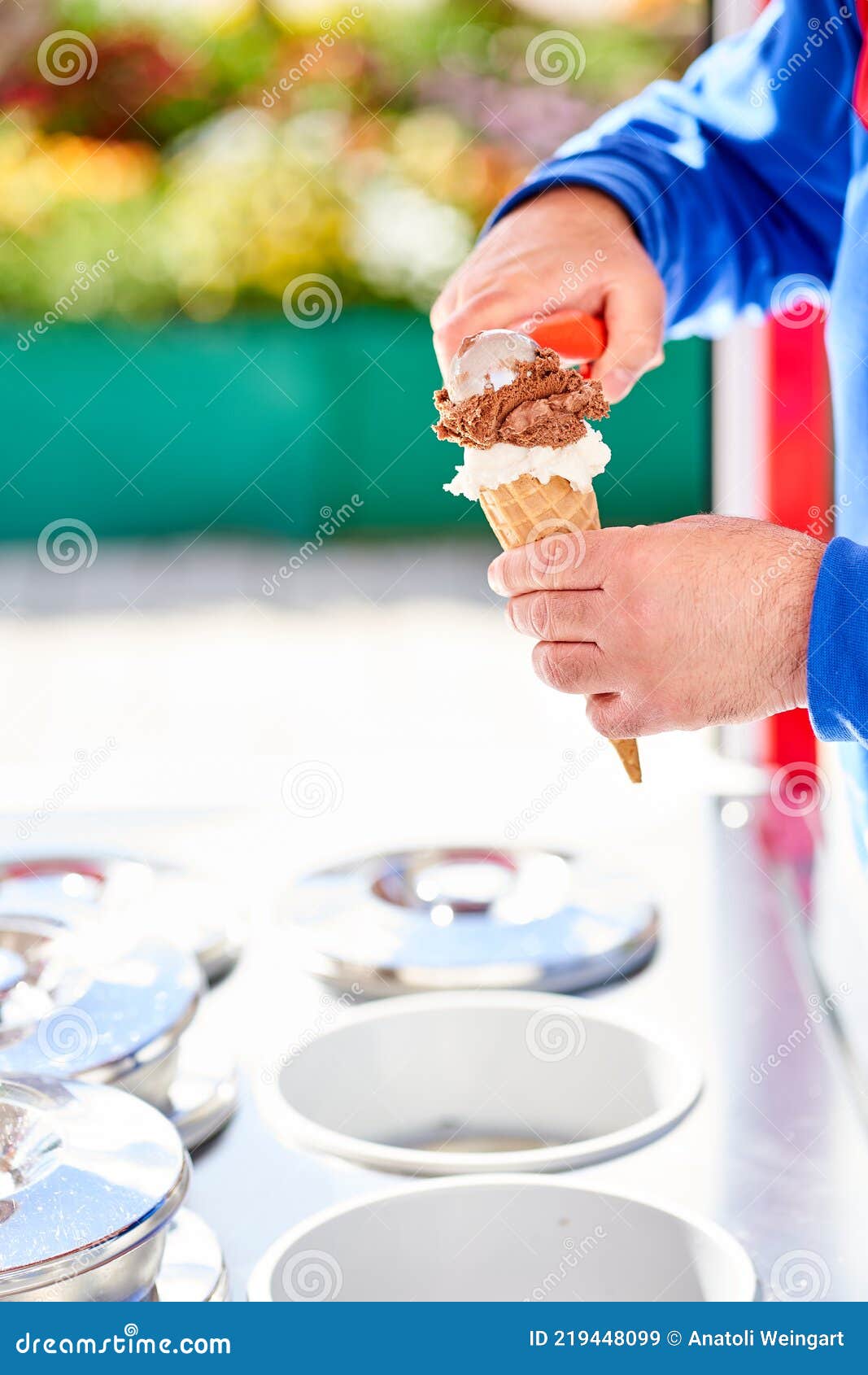 Hands Scooping Ice Cream into Waffle at Shop. Outdoor Stock Image ...