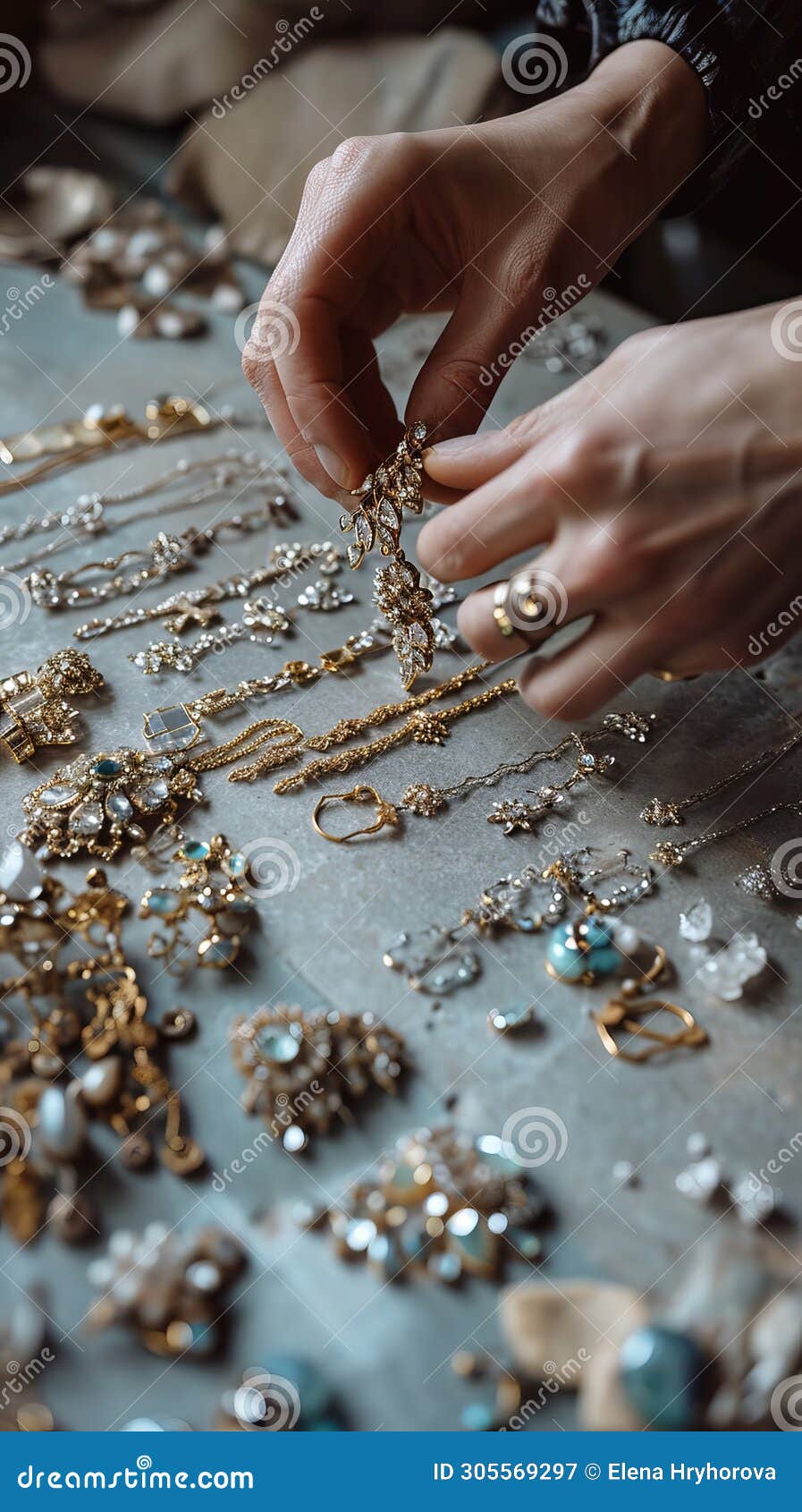 Hands Selecting from an Array of Gold Jewelry Pieces Stock Image ...