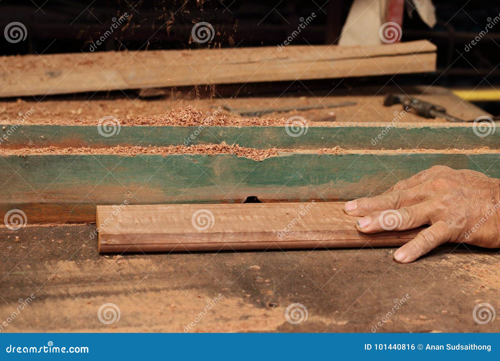 Hands of Senior Carpenter Shaving a Piece of Wood on Router Table in ...