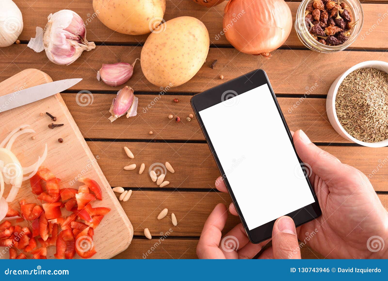 Hands with Smartphone in Kitchen Preparing a Menu Top Stock Photo ...