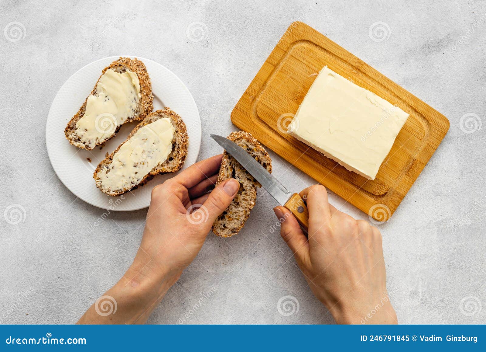Hands Spreading Butter with Knife on Toast Bread. Top View Stock Image ...