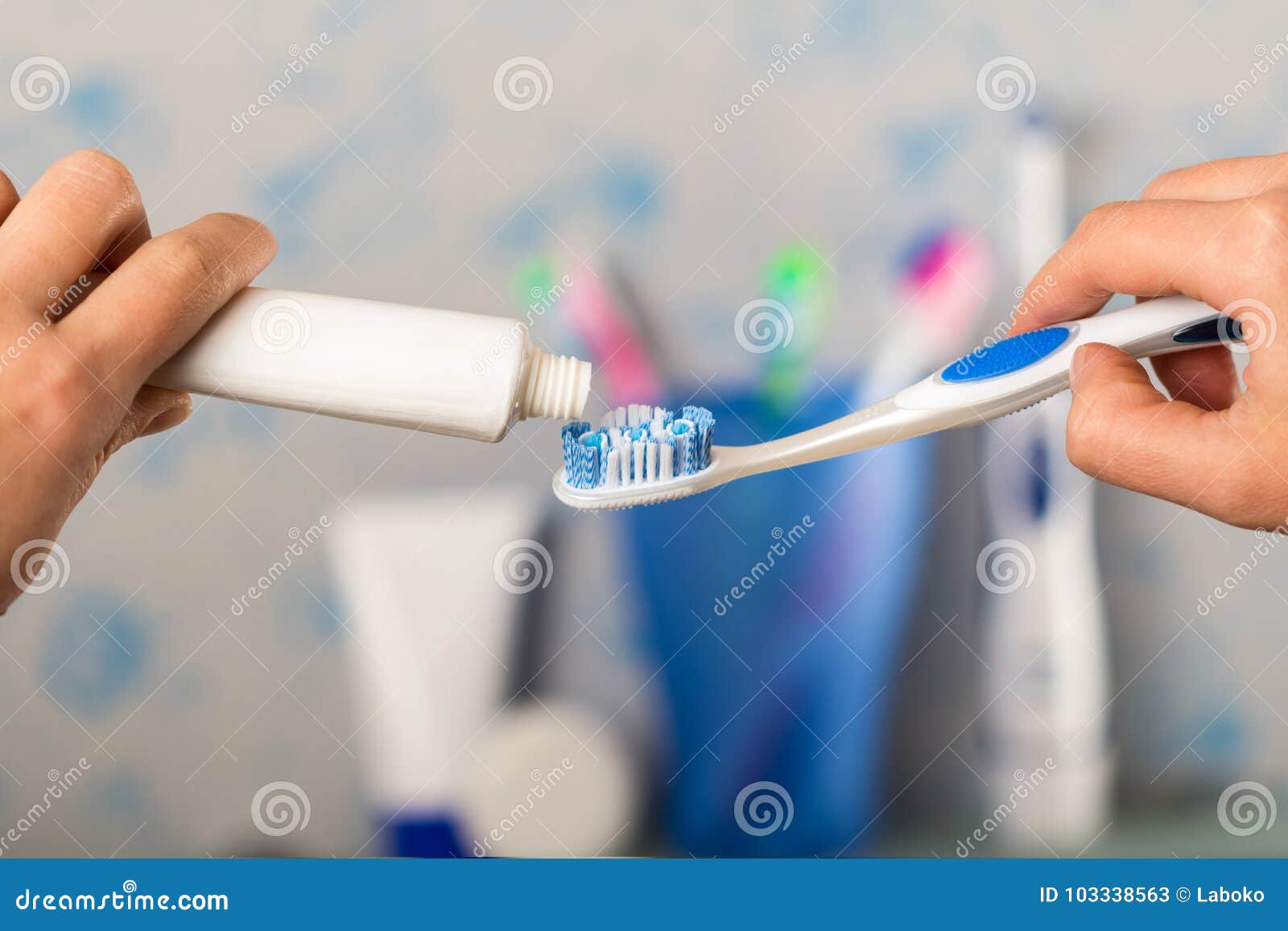 Hands Squeeze Toothpaste on the Brush in the Bathroom Stock Image ...