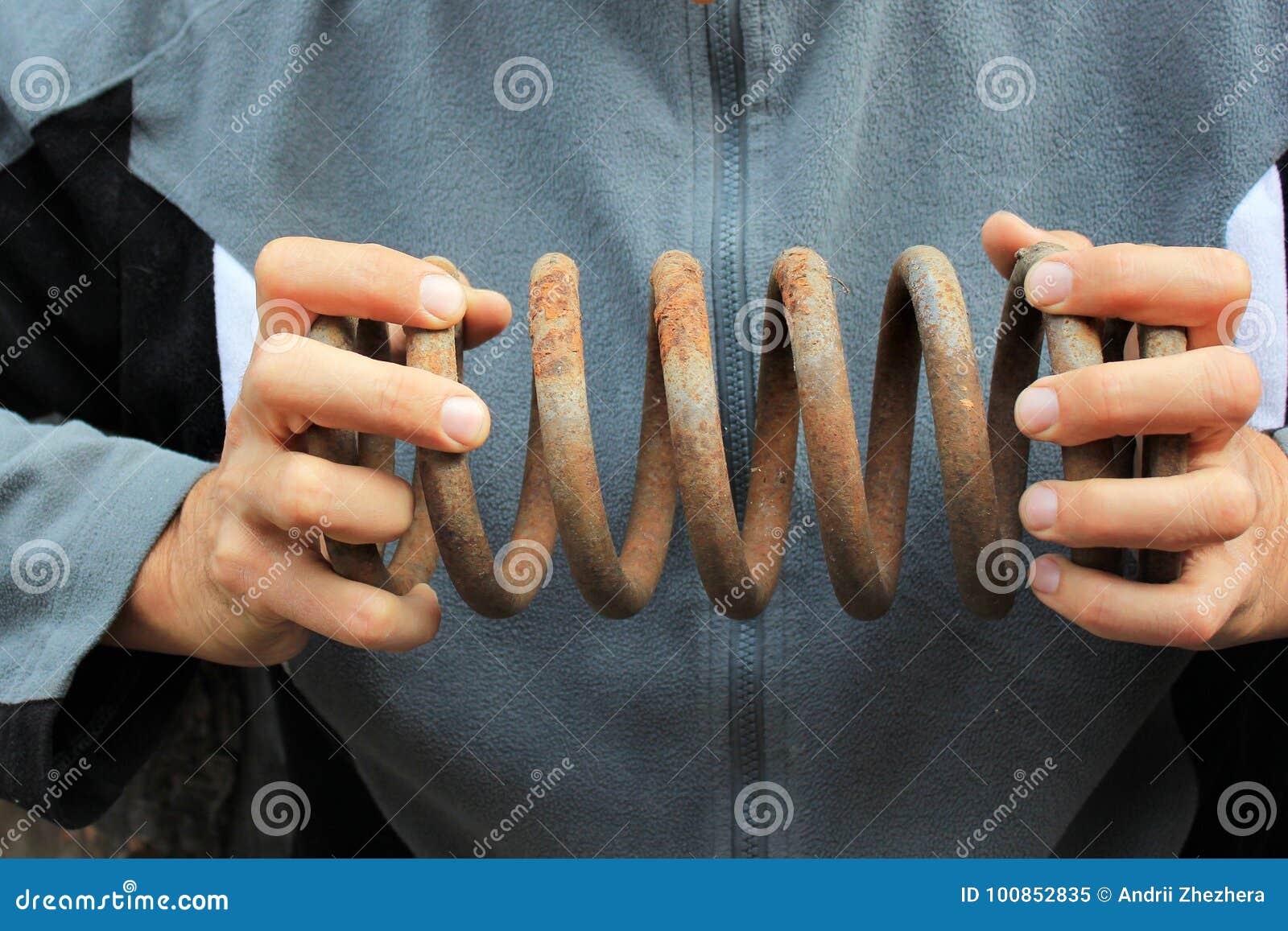 Hands Squeezing Big Rusty Metal Spring Stock Image - Image of rust ...