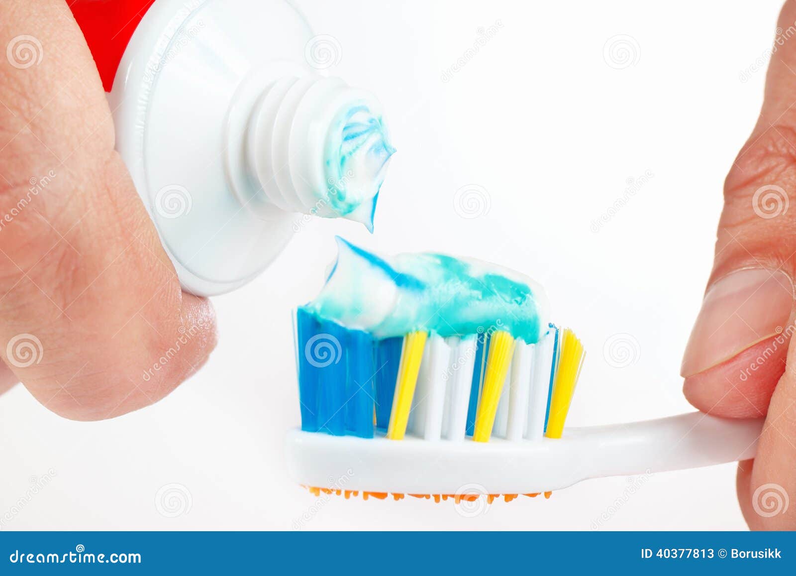Hands Squeezing Toothpaste from a Tube on the Toothbrush Stock Image ...