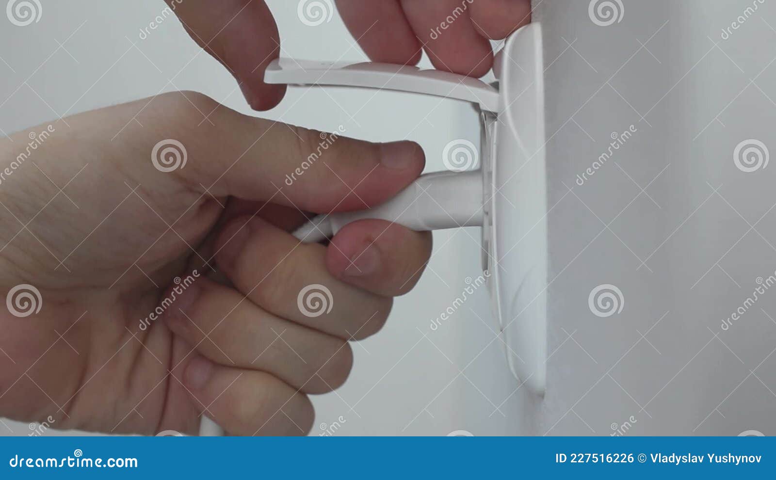 Hands Switch on the White Power Plug into the Electrical Socket on the ...