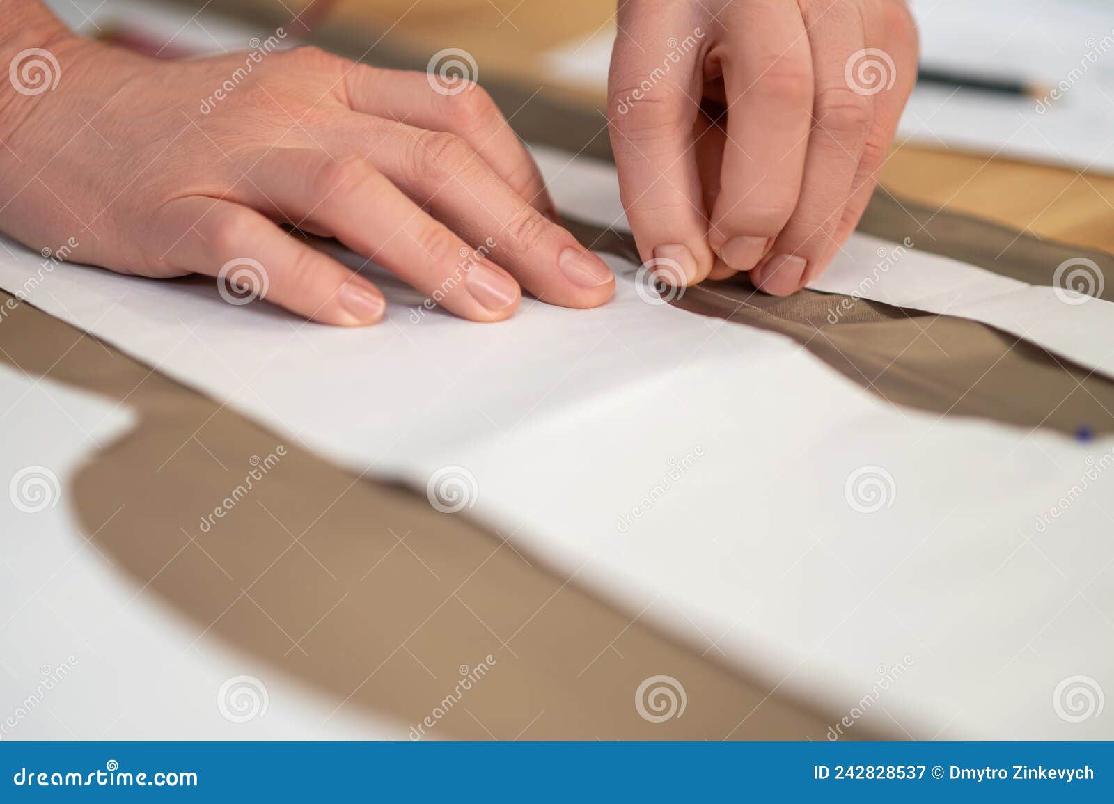 Hands of Tailor with Needle Touching Pattern on Fabric Stock Image ...