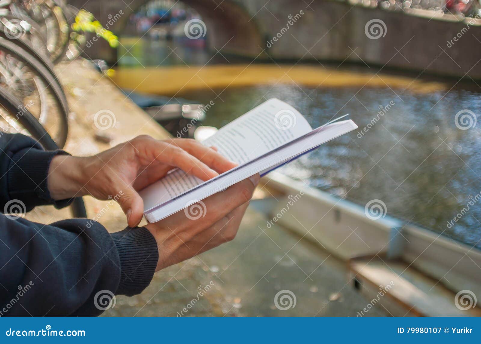 Hands taking opened book stock image. Image of reading - 79980107