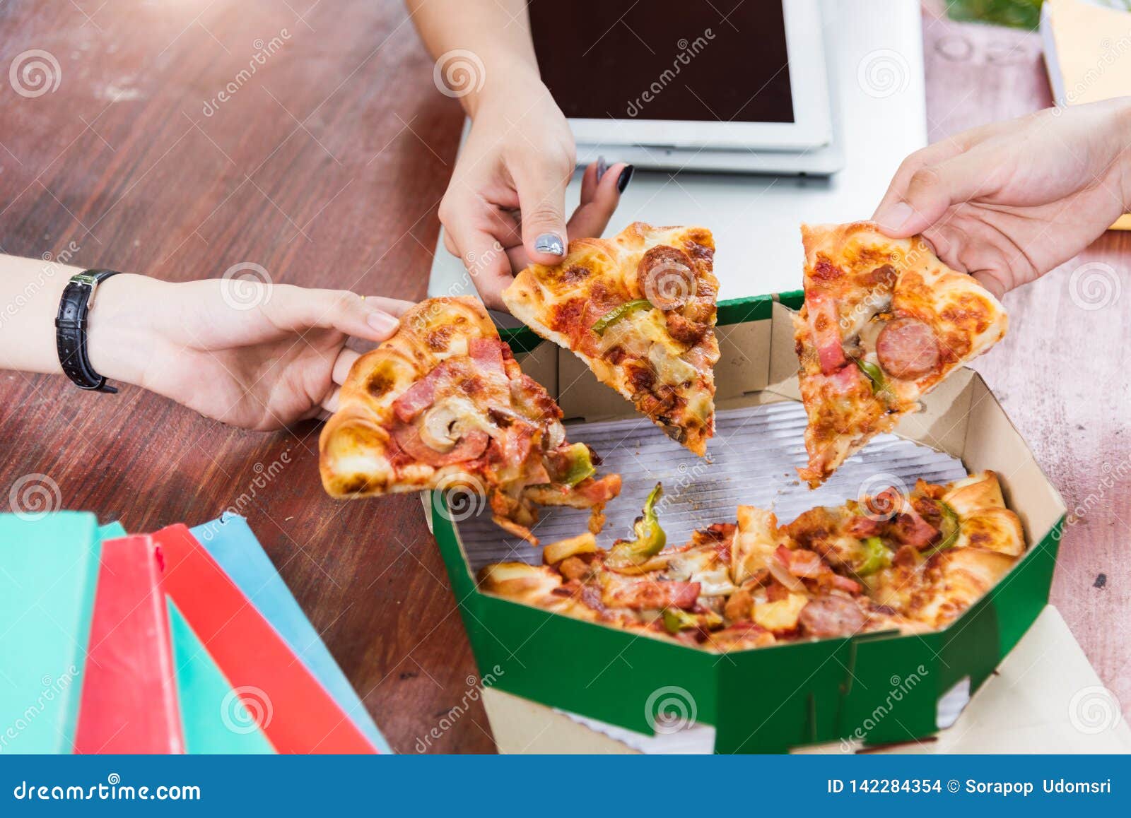 Hands taking pizza slices stock photo. Image of meal - 142284354