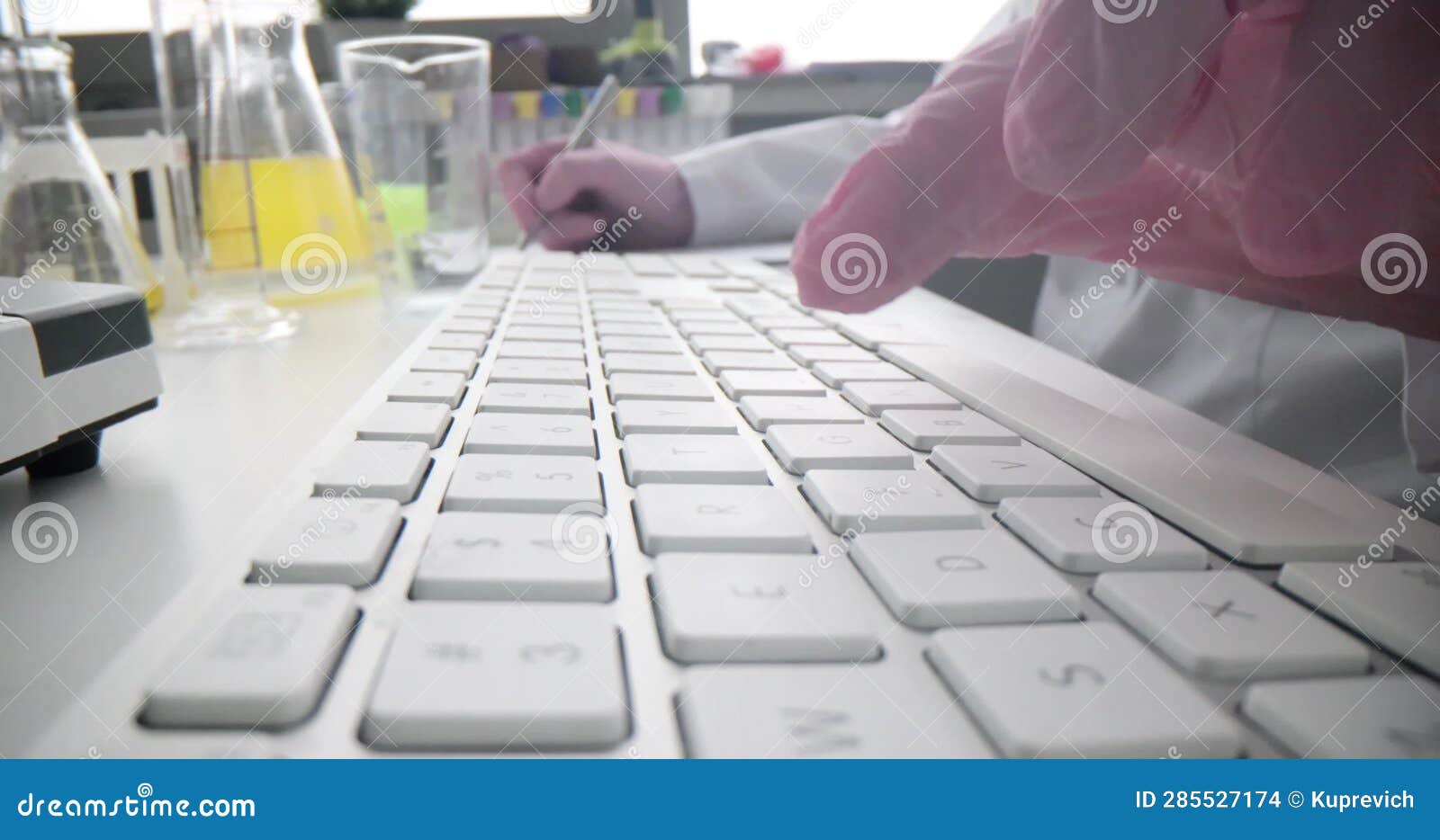 A Chemist in a Laboratory is Typing on a Computer Keyboard Stock ...