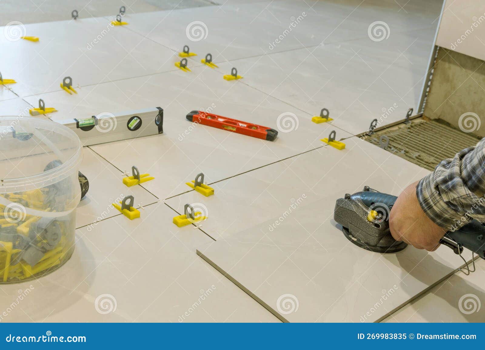 The Hands of the Tiler are Laying the Ceramic Tile on the Floor. Stock ...