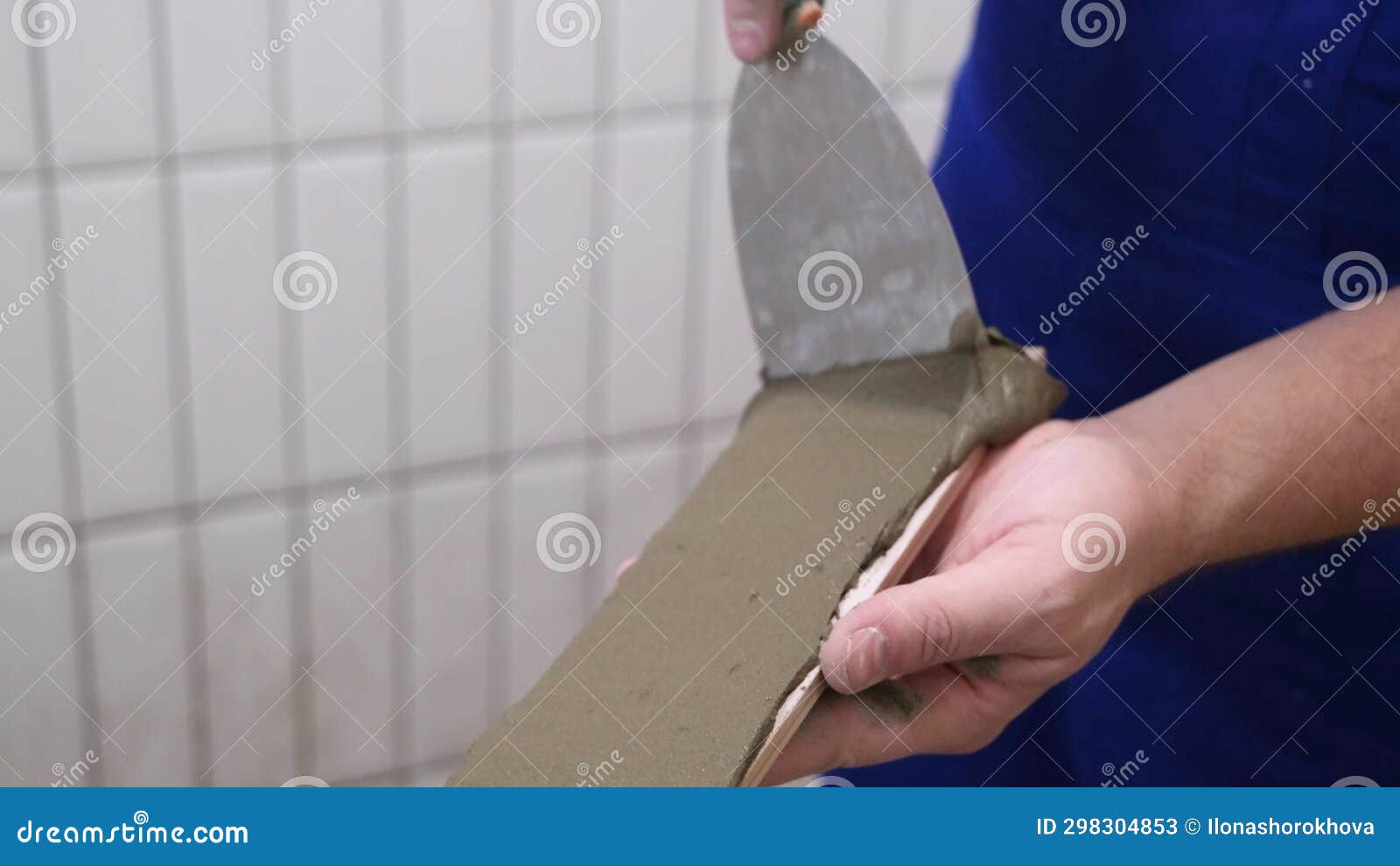 The Hands of the Tiler are Laying the Ceramic Tile on the Wall Stock ...
