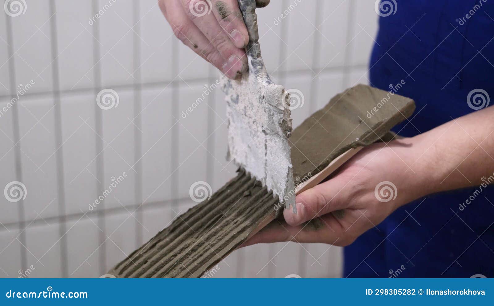The Hands of the Tiler are Laying the Ceramic Tile on the Wall Stock ...
