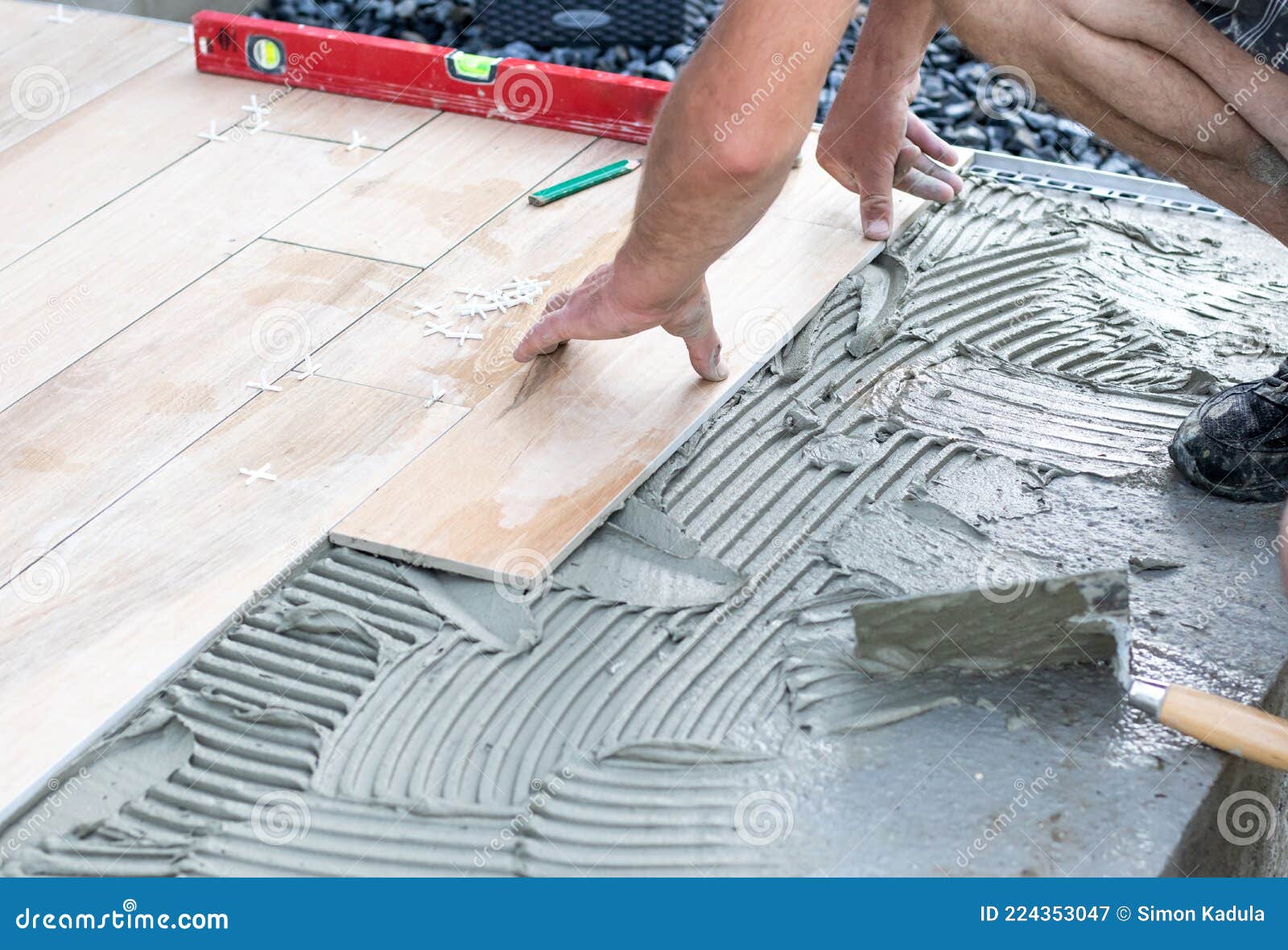 The Hands of the Tiler Lying or Installing Modern, Ceramic Tile Above ...