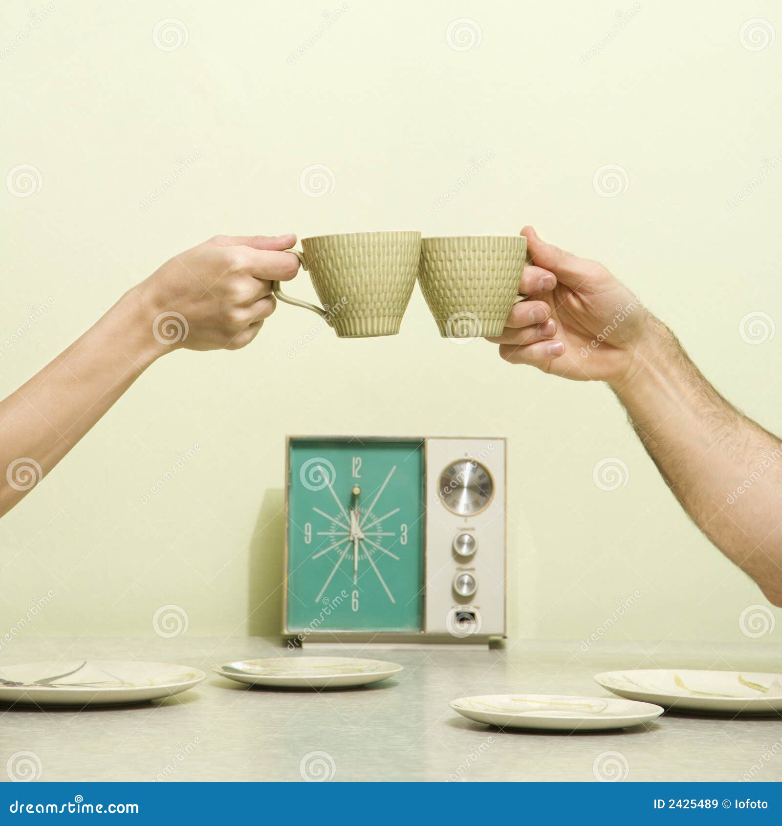 Hands toasting cups. stock image. Image of photograph - 2425489