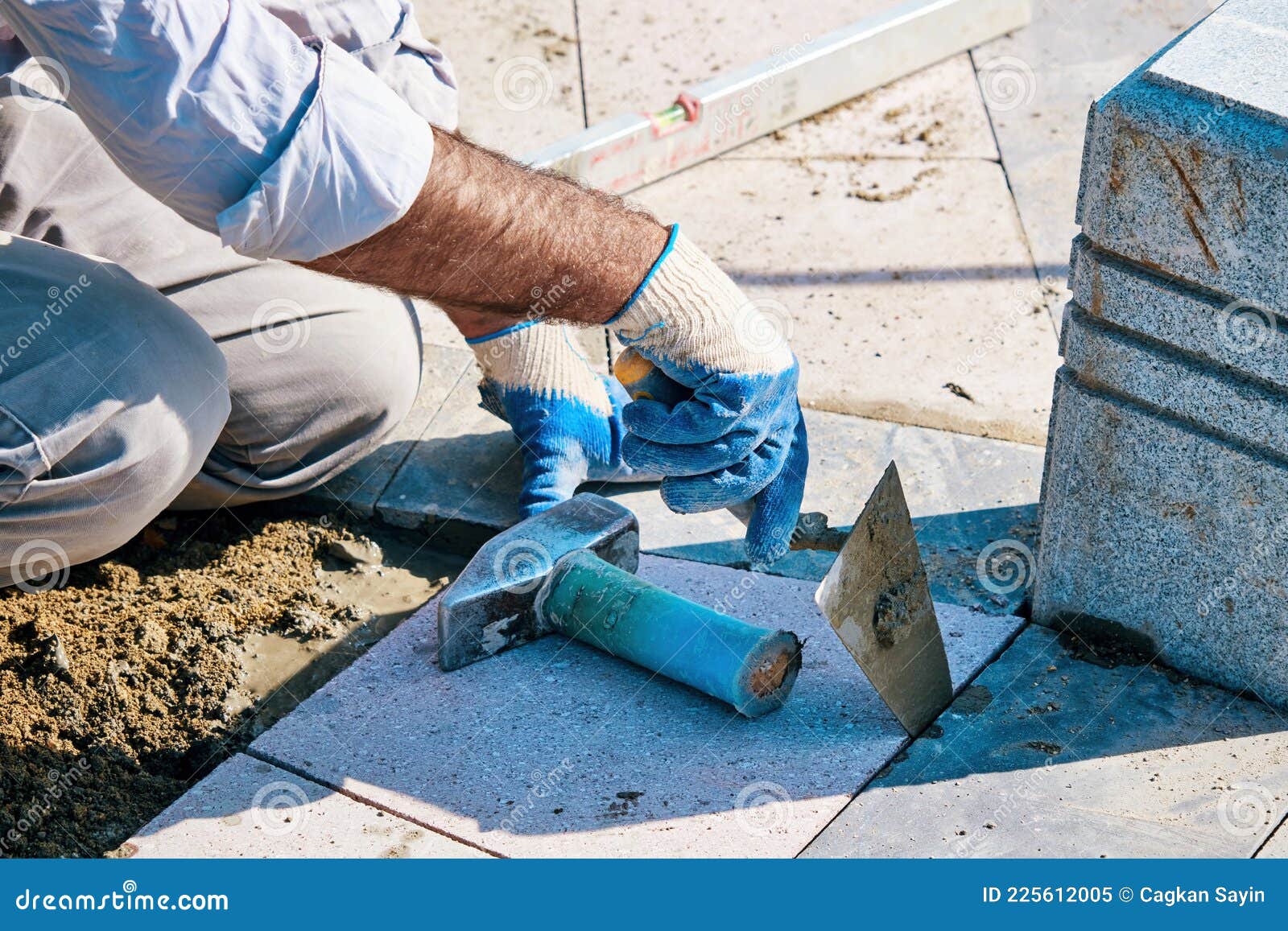 Hands of a Turkish Pavement Construction Worker Installing Tiles with a ...