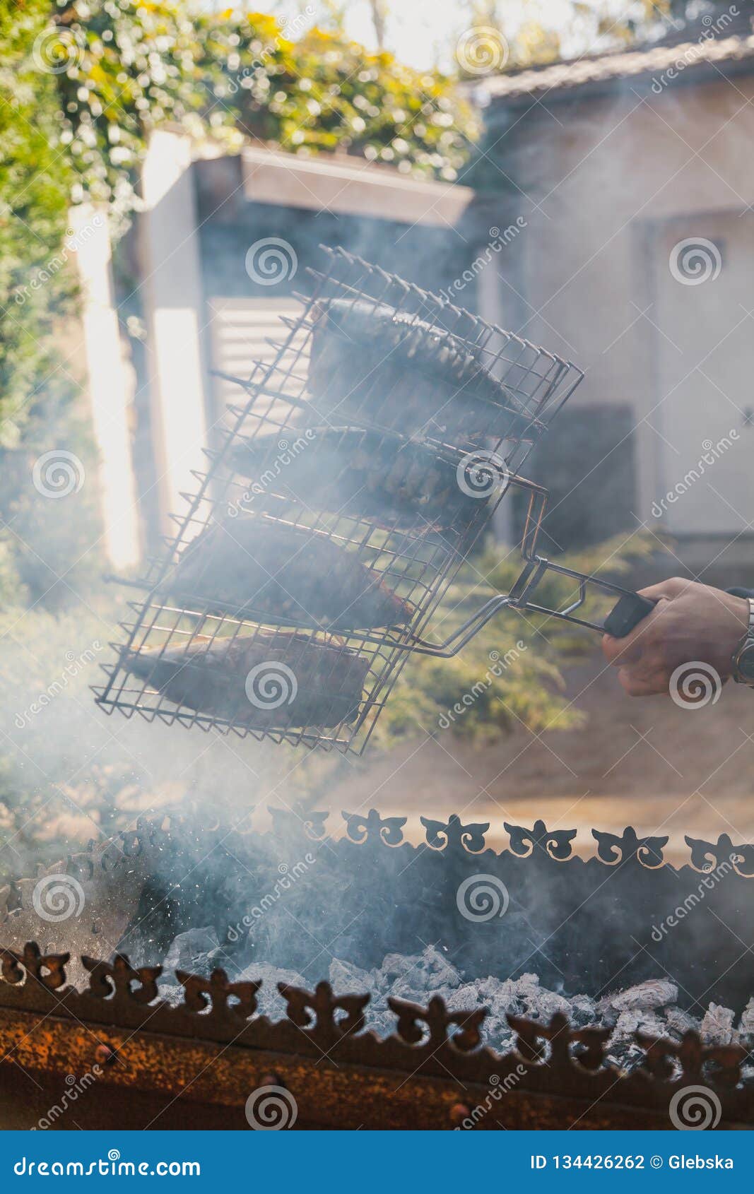 Hands Turn Grill with Fish Over Brazier Stock Photo - Image of laid ...
