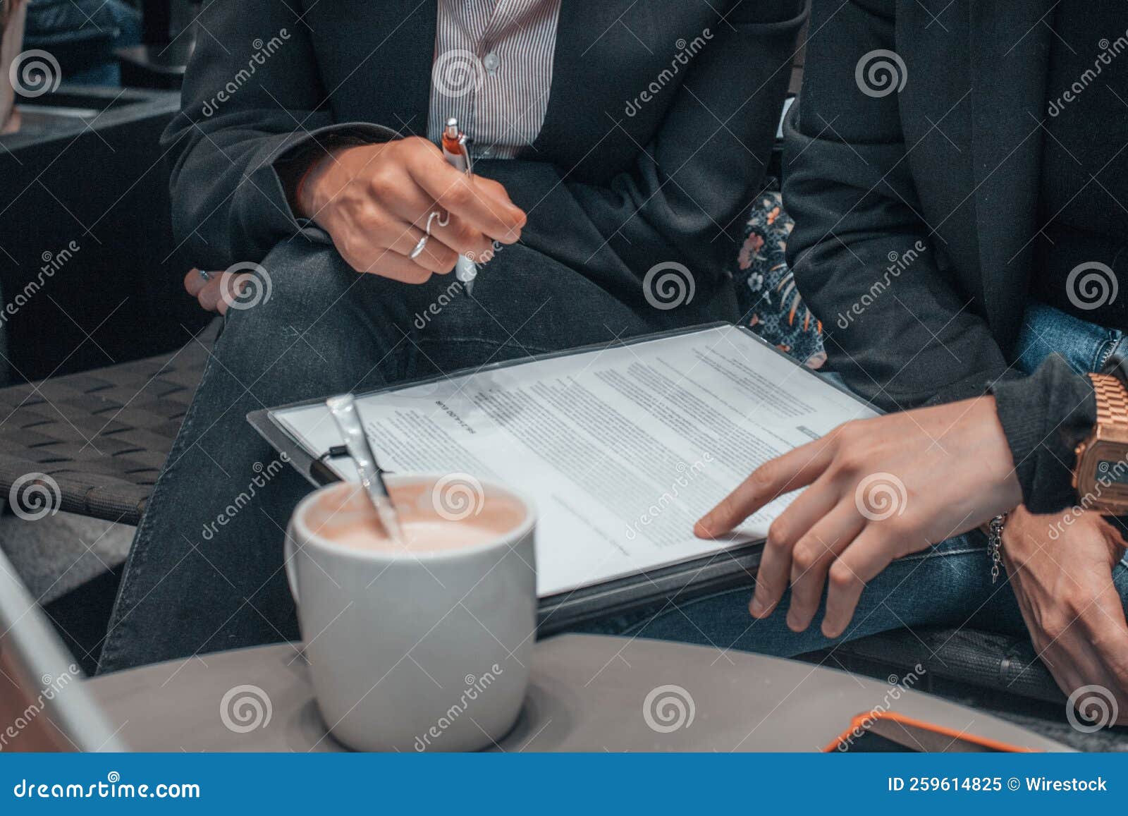 Hands of Two Females Checking a List on Their Lap Stock Image - Image ...