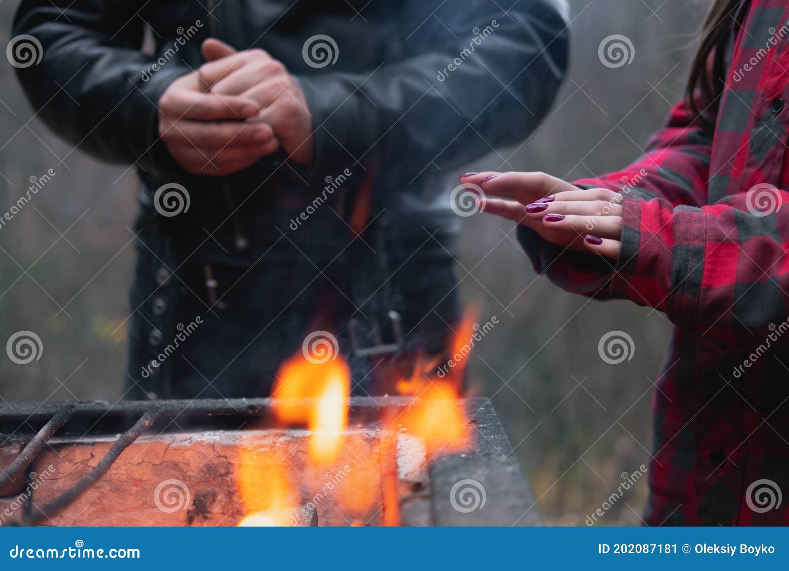 Hands of Two People Getting Warm from a Fire Outdoors. Stock Image ...