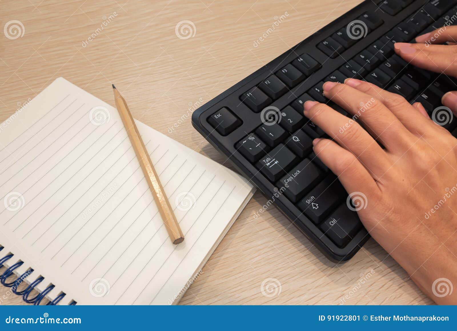 Hands Typing Keyboard with a Blank Notepad and Pencil on Wooden Stock ...