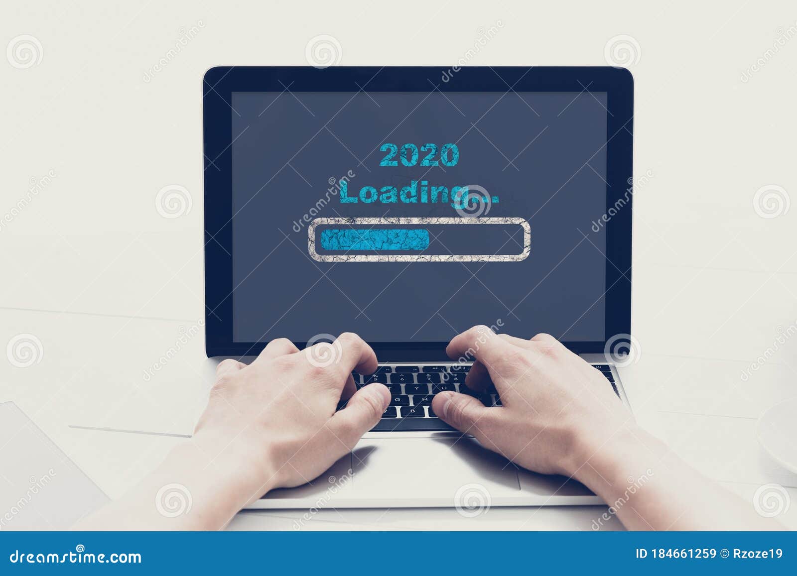 Hands Typing on a Laptop Keyboard. 2020 is Loading on the Screen Stock ...
