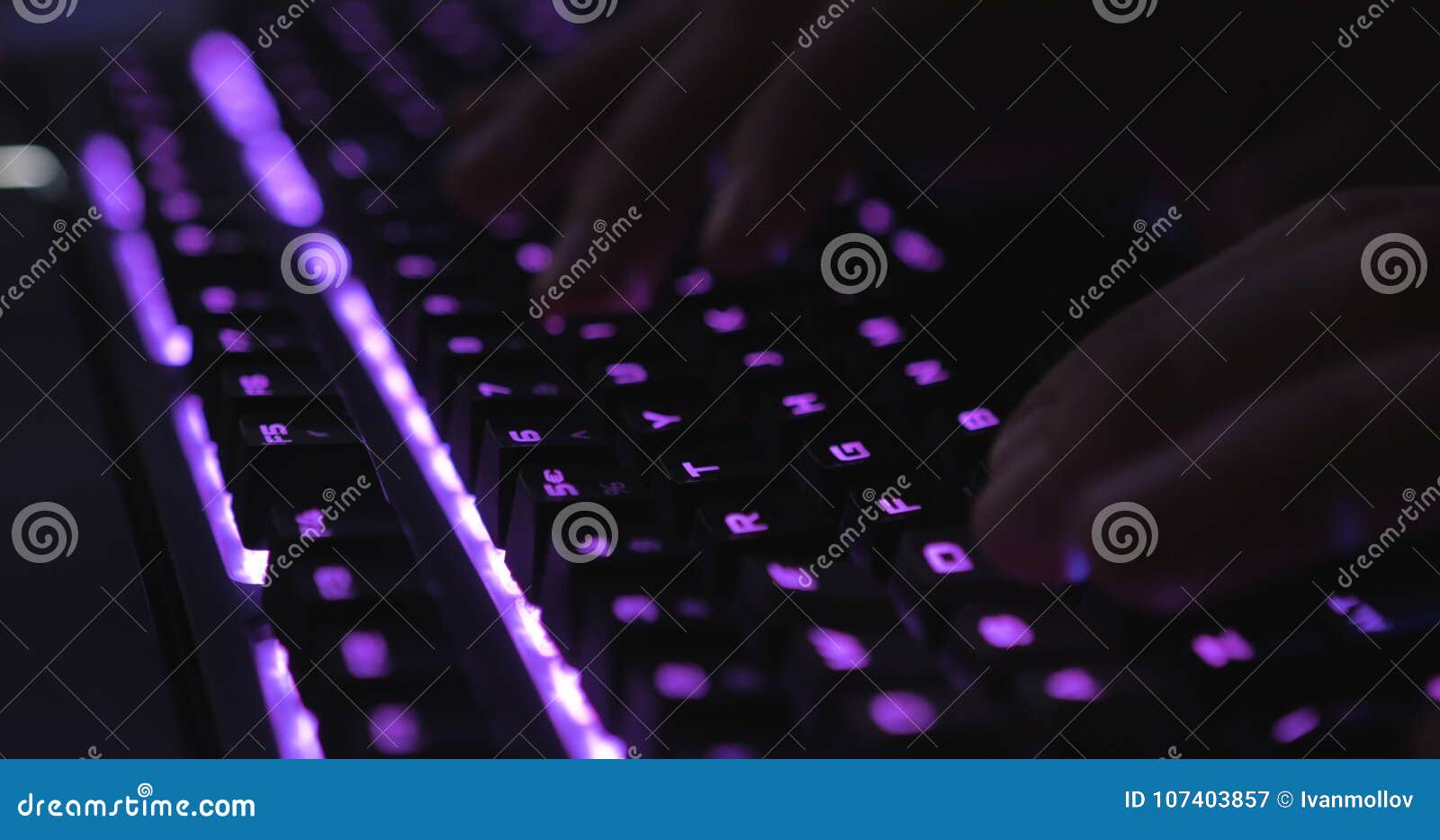 Hands Typing on Multi Colored Led Keyboard in Dark Environment Closeup ...