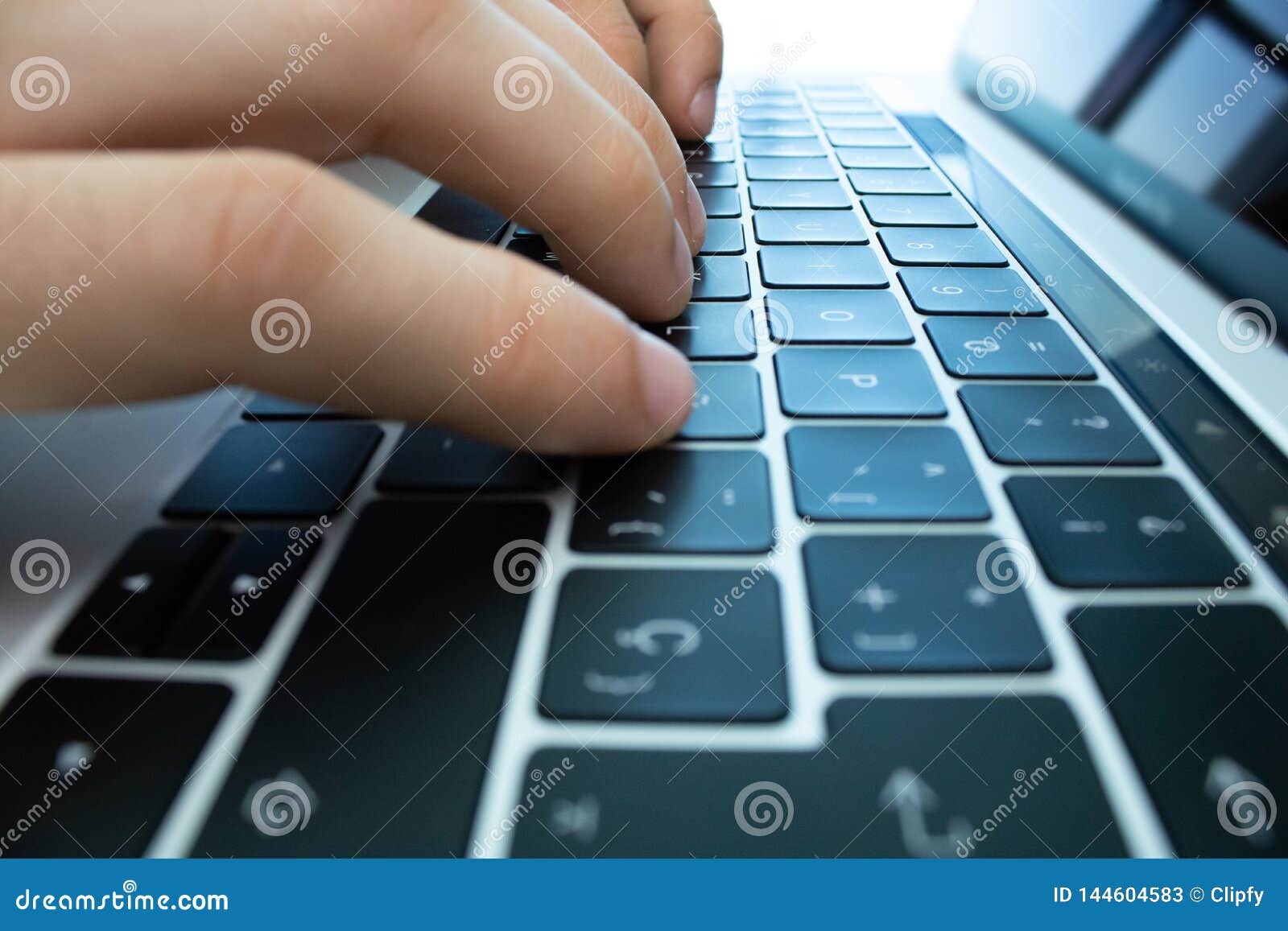 Hands Using the Keyboard and Touchpad of a Laptop Computer on a White ...