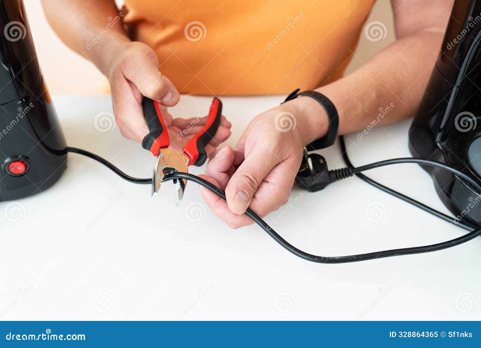 Hands Using Pliers To Cut a Black Cable on a White Background ...
