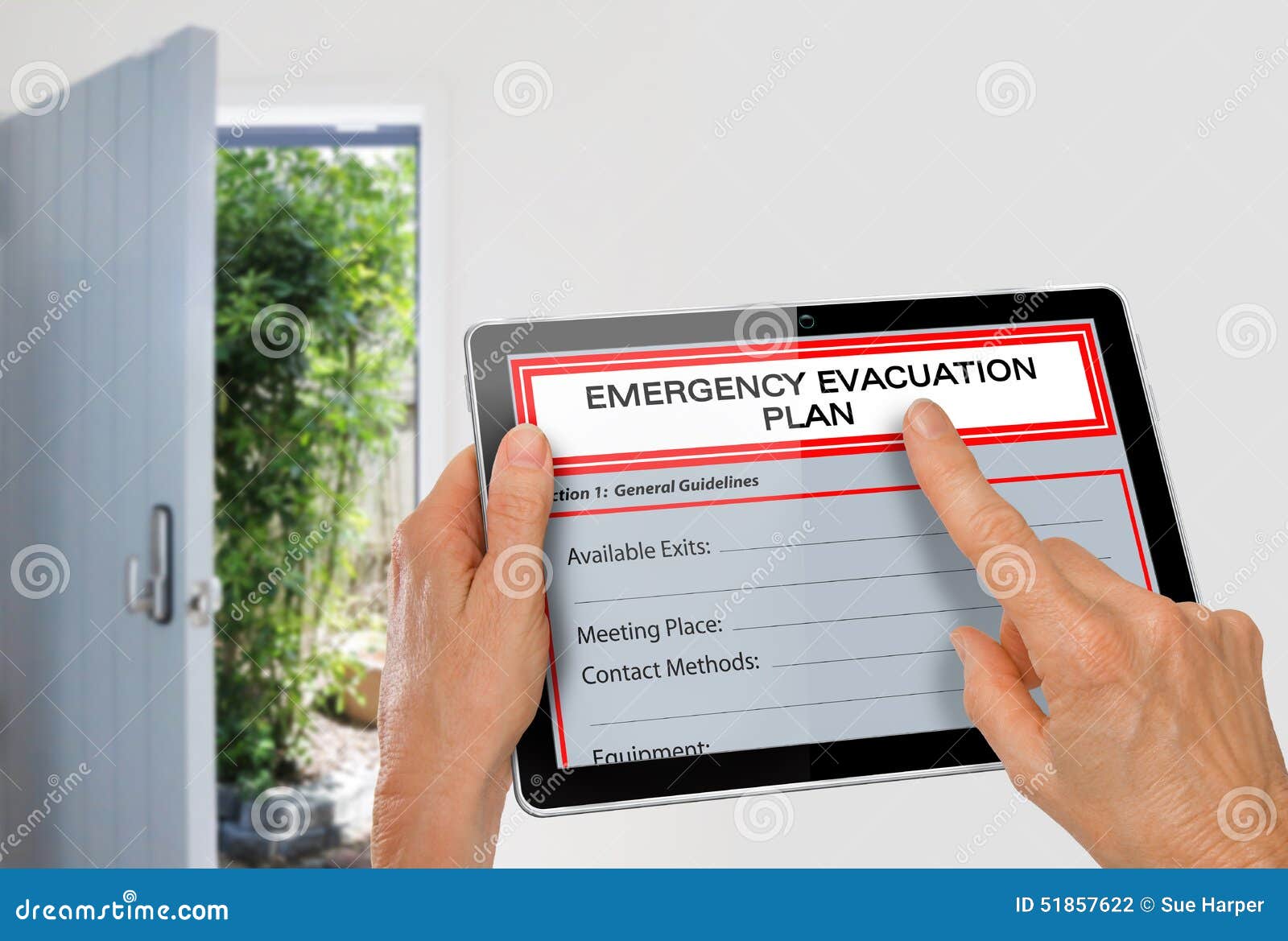 Hands Using Tablet with Emergency Evacuation Plan beside Exit Door ...